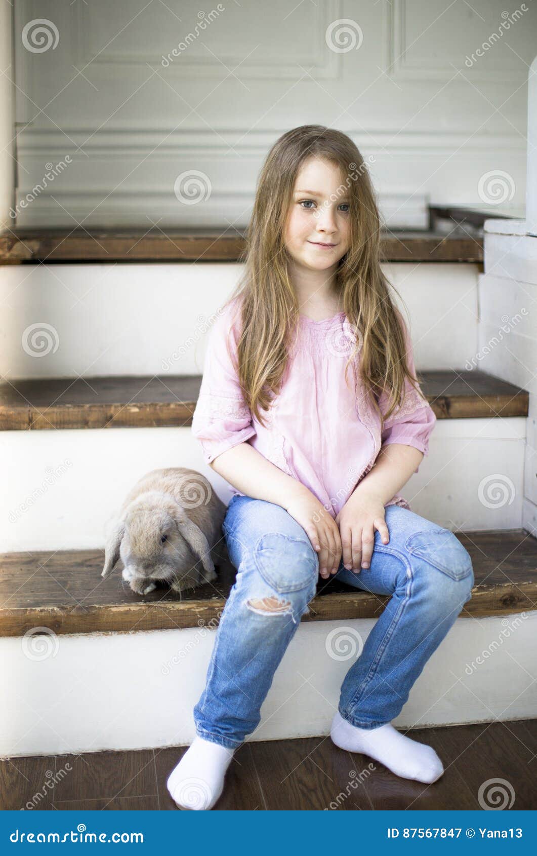Girl with a Rabbit Sitting on the Stairs in the House Stock Image ...