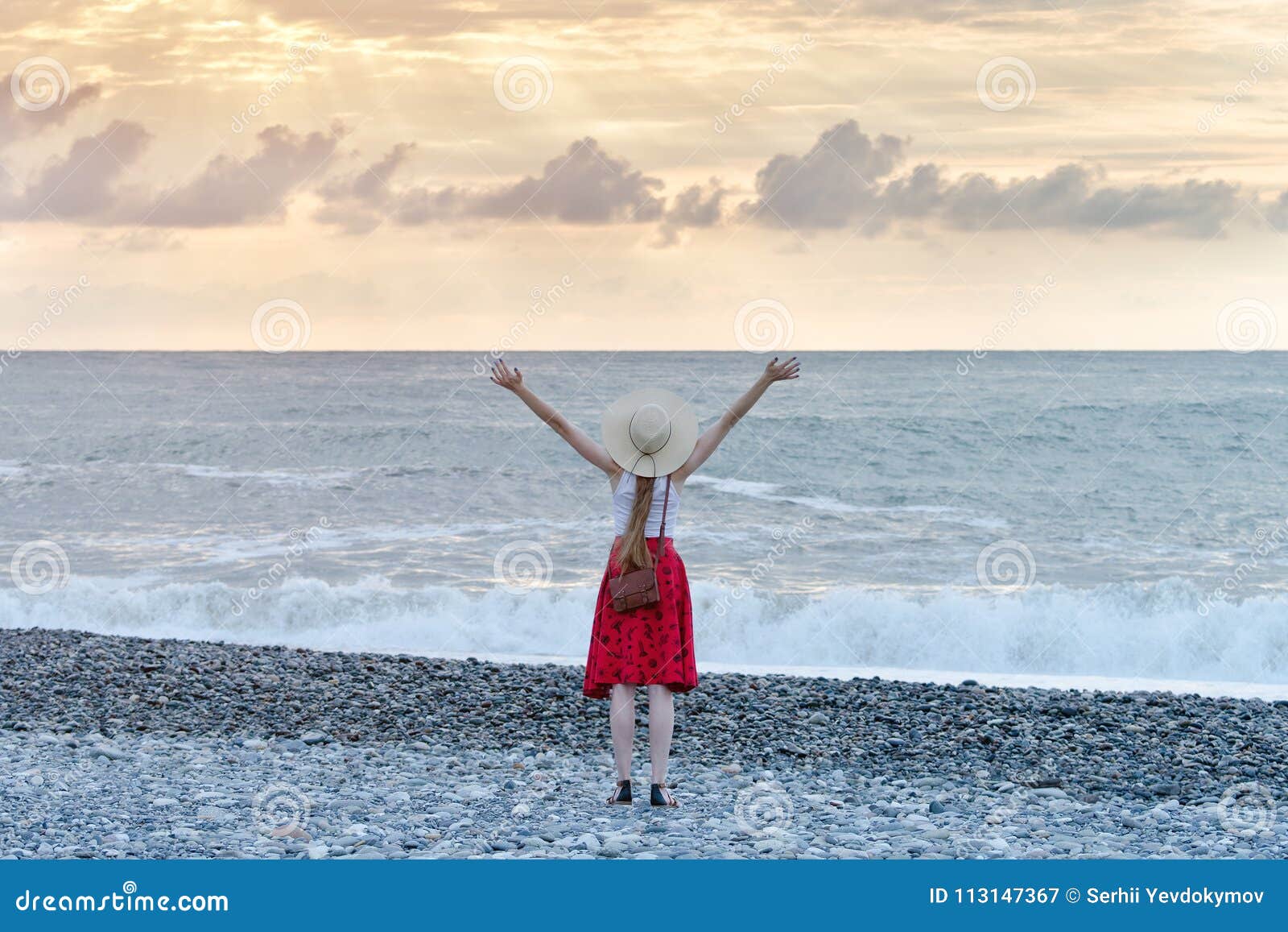 Girl with Raised Hands Standing by the Sea, Sunset. Back View Stock ...