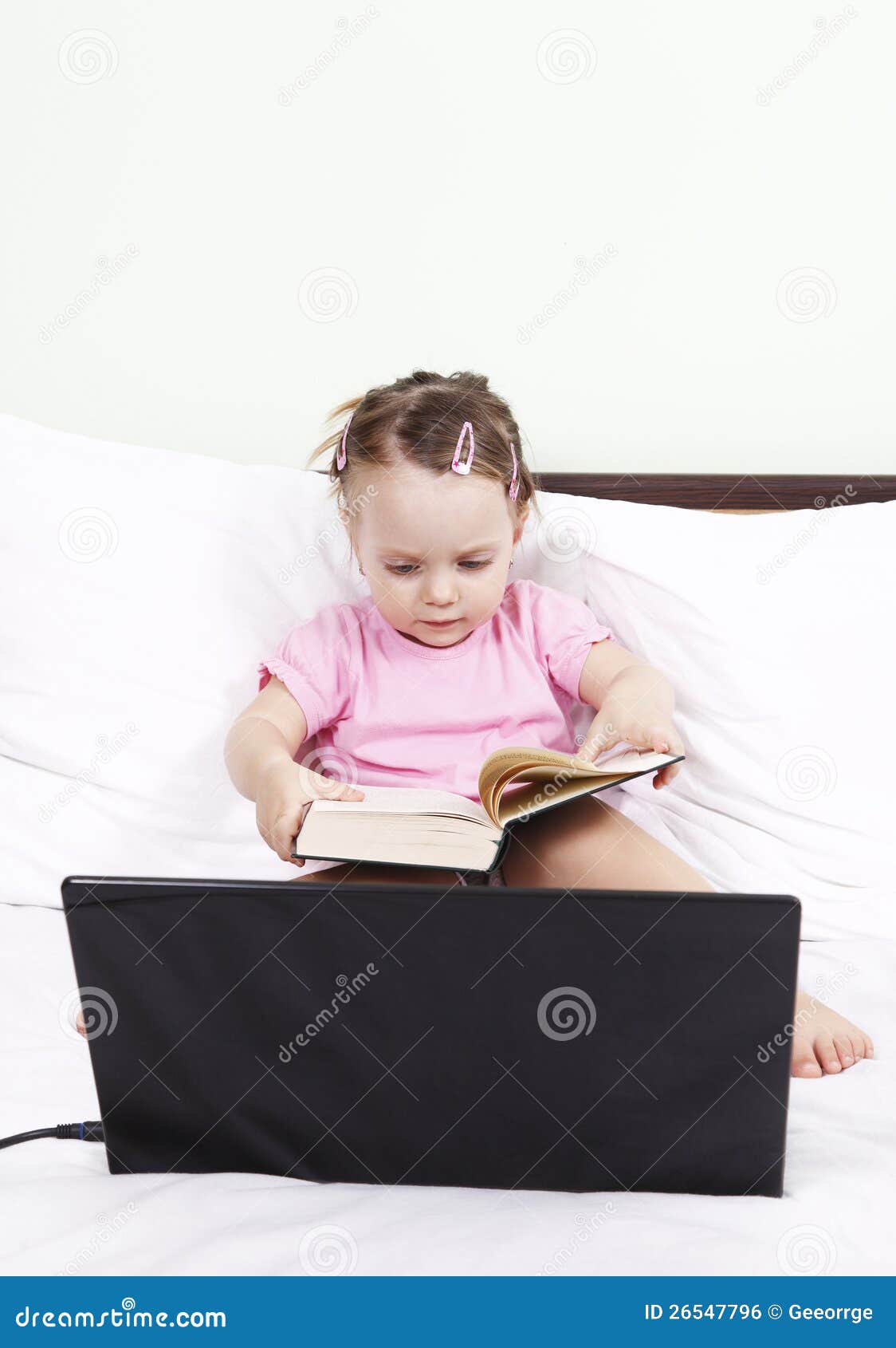 Girl Reading a Book in Front of a Laptop Stock Photo - Image of little ...