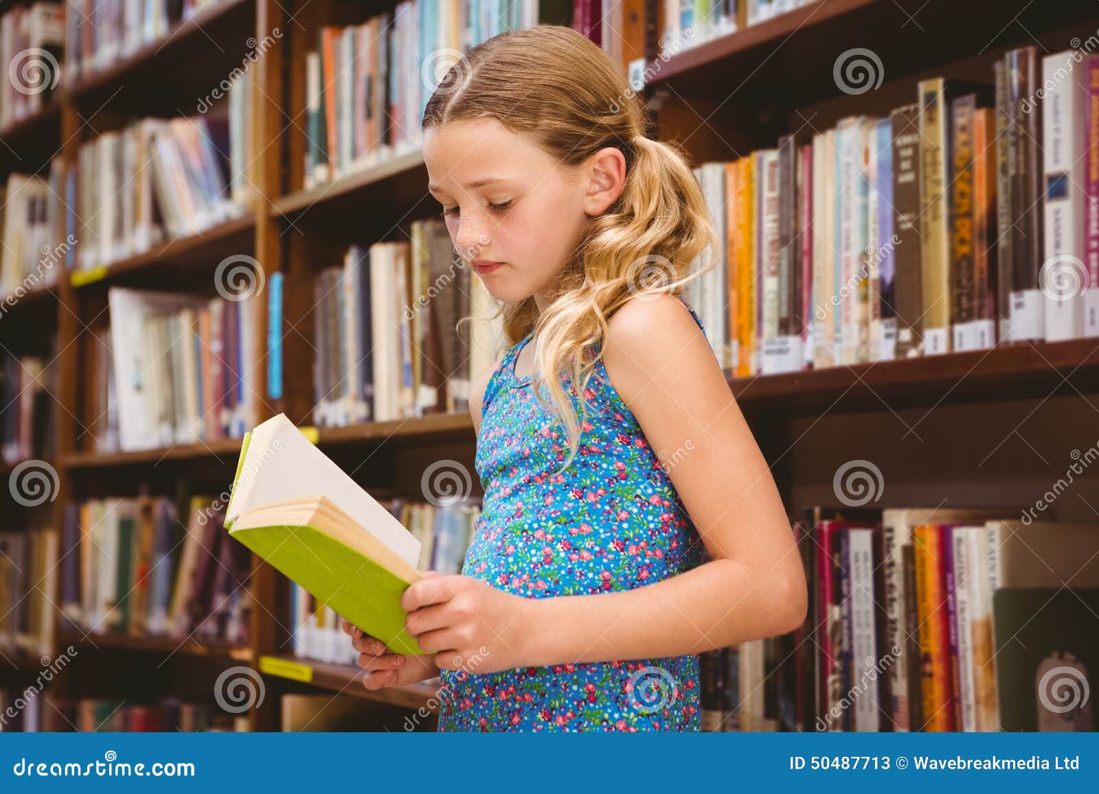 Girl Reading Book in Library Stock Image - Image of education ...