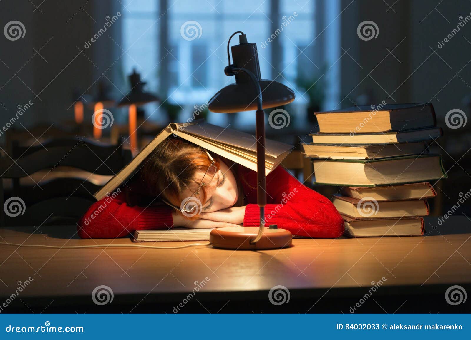 Girl Reading a Book in the Library Under the Lamp Stock Image - Image ...