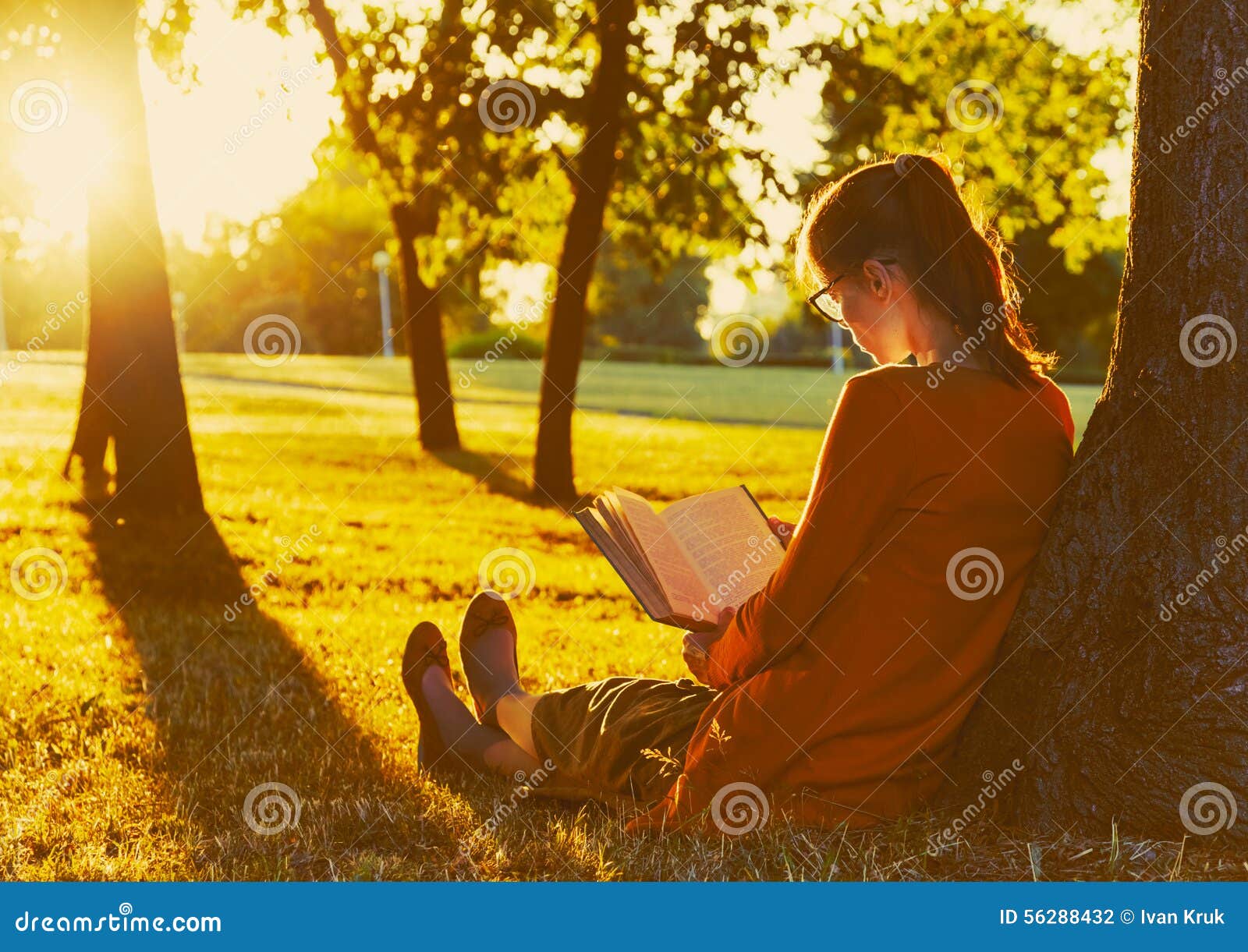 Girl reading book at park stock photo. Image of hand - 56288432