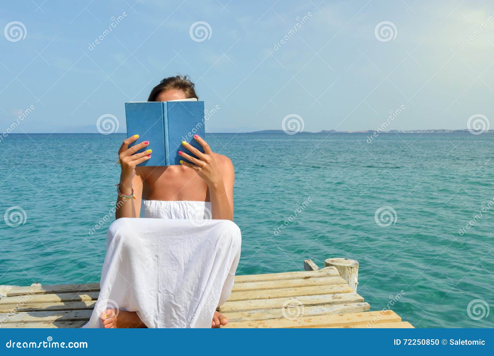 Girl Reading a Book Sitting on a Dock Stock Photo - Image of seaside ...
