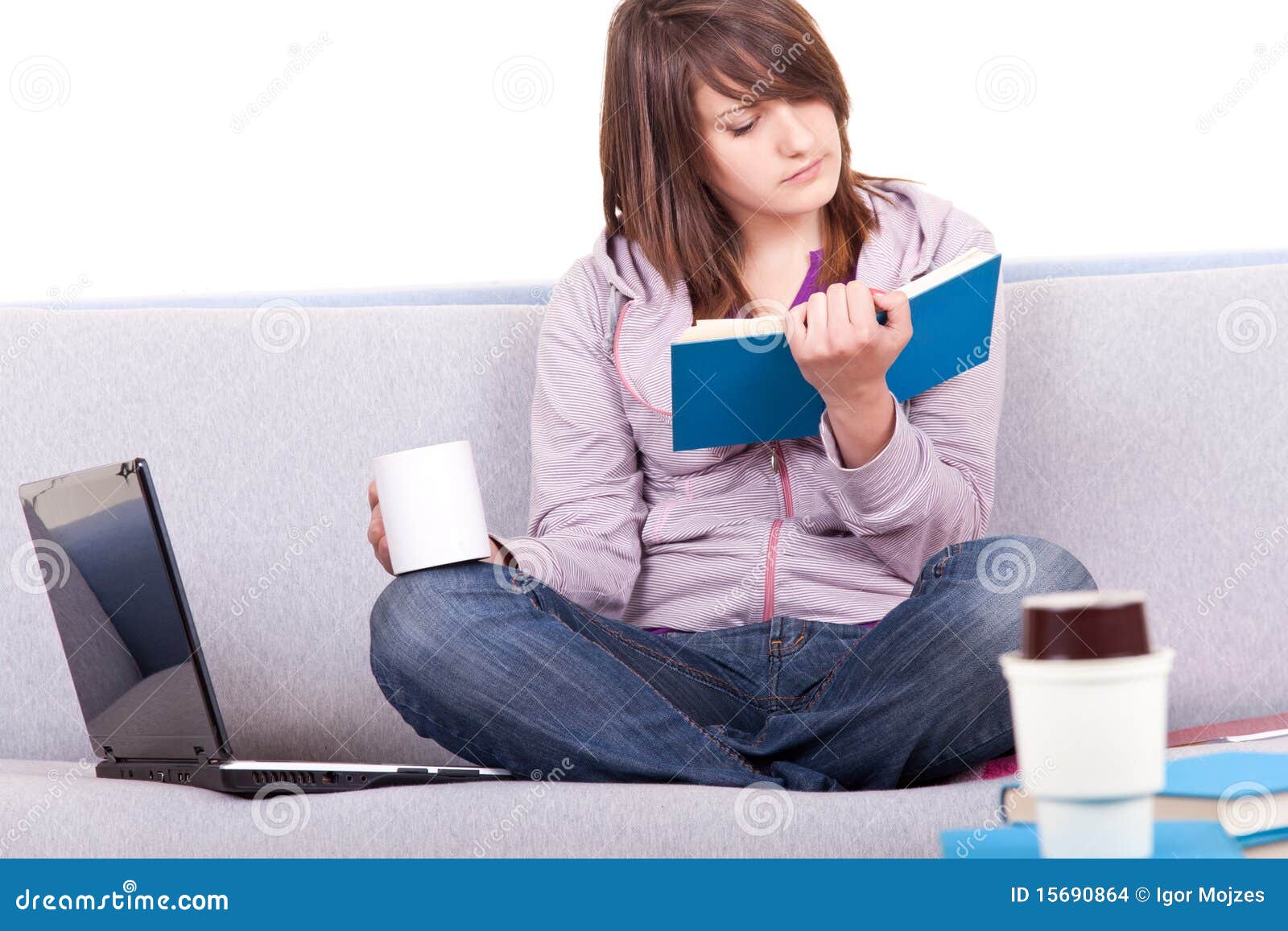 Girl reading book on sofa stock photo. Image of teen - 15690864