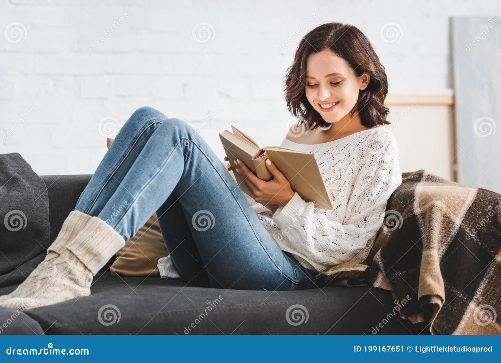 Girl Reading Book on Sofa at Home Stock Image - Image of happiness ...