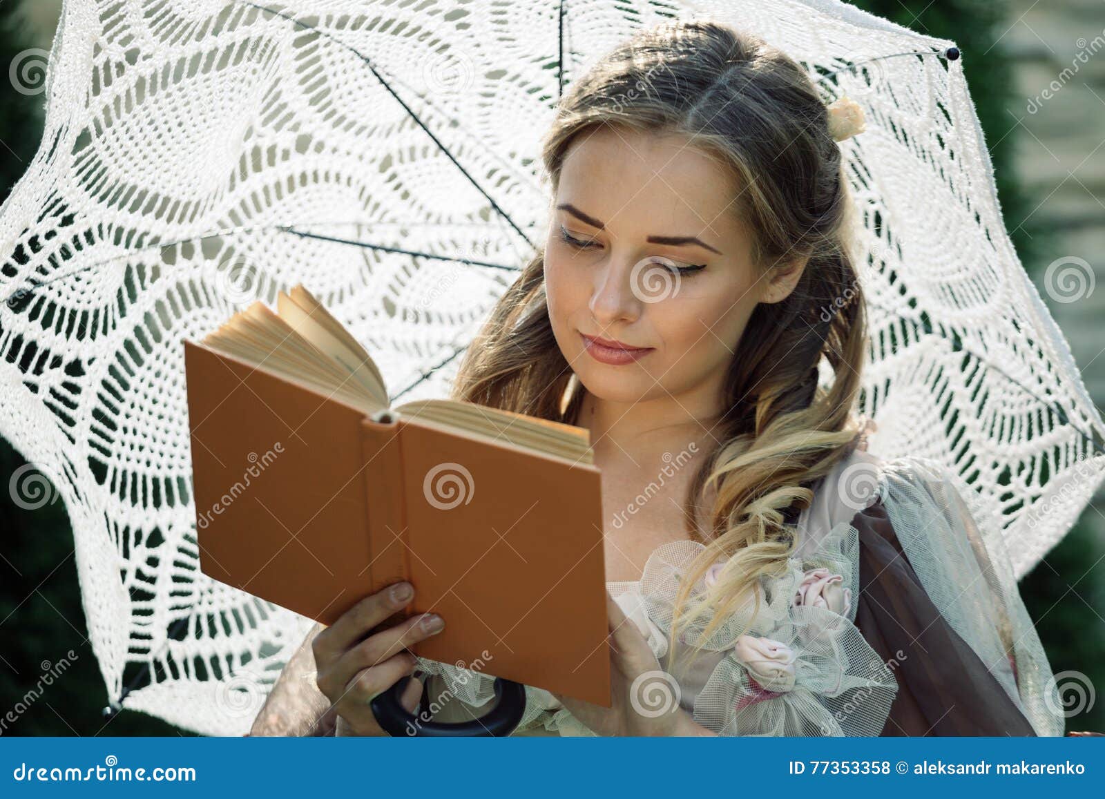 Girl Reading a Book while Standing Under an Umbrella Stock Photo ...