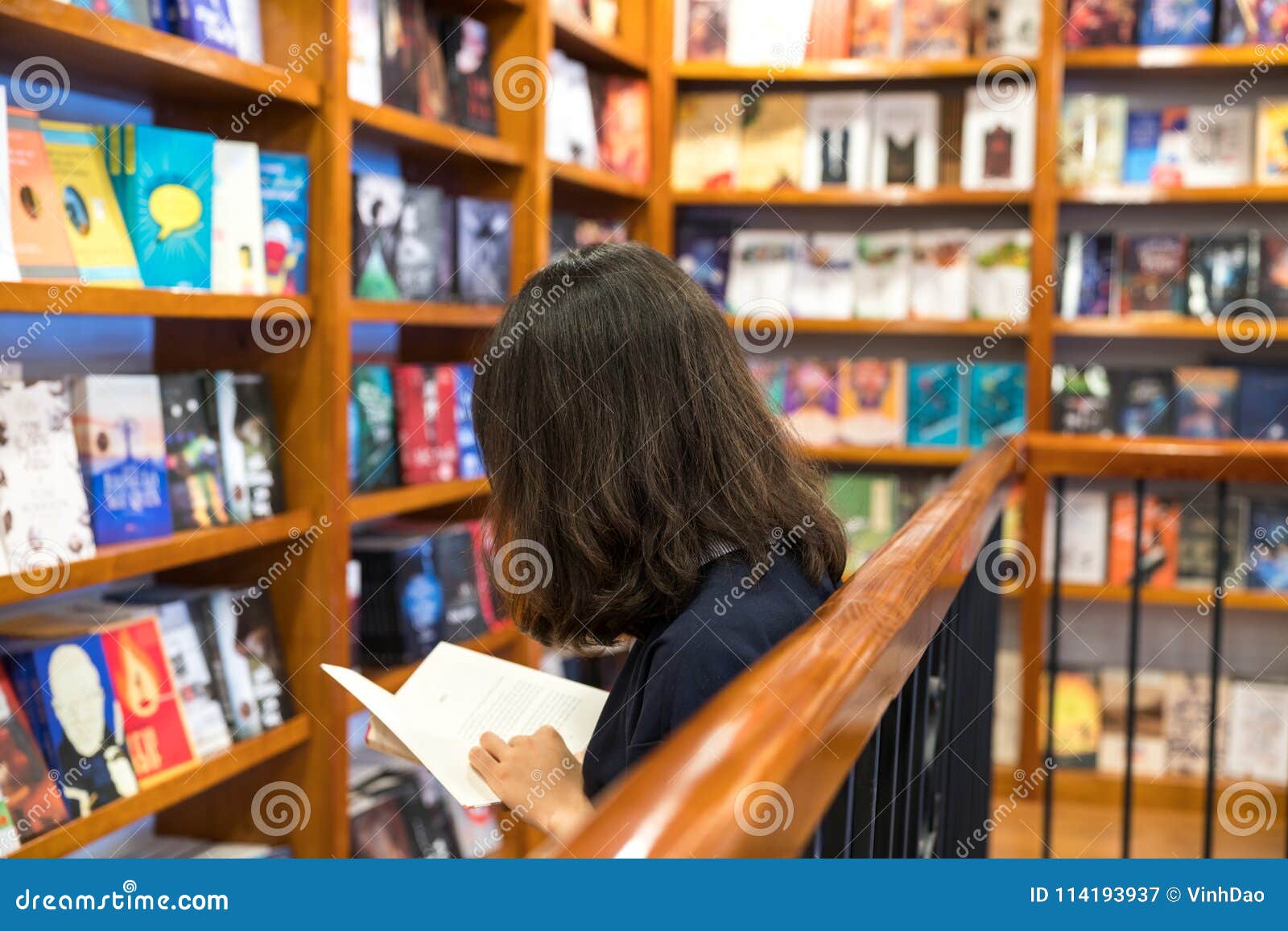 A Girl Reading Book in the Store Closeup Editorial Photography - Image ...