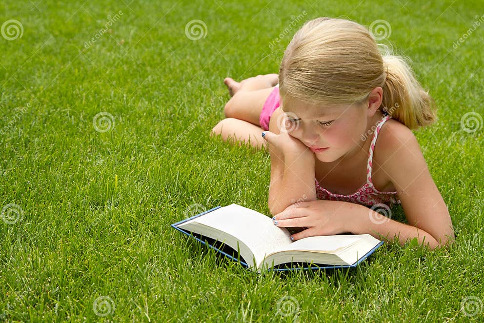 Girl reading in the grass stock image. Image of attractive - 25952761