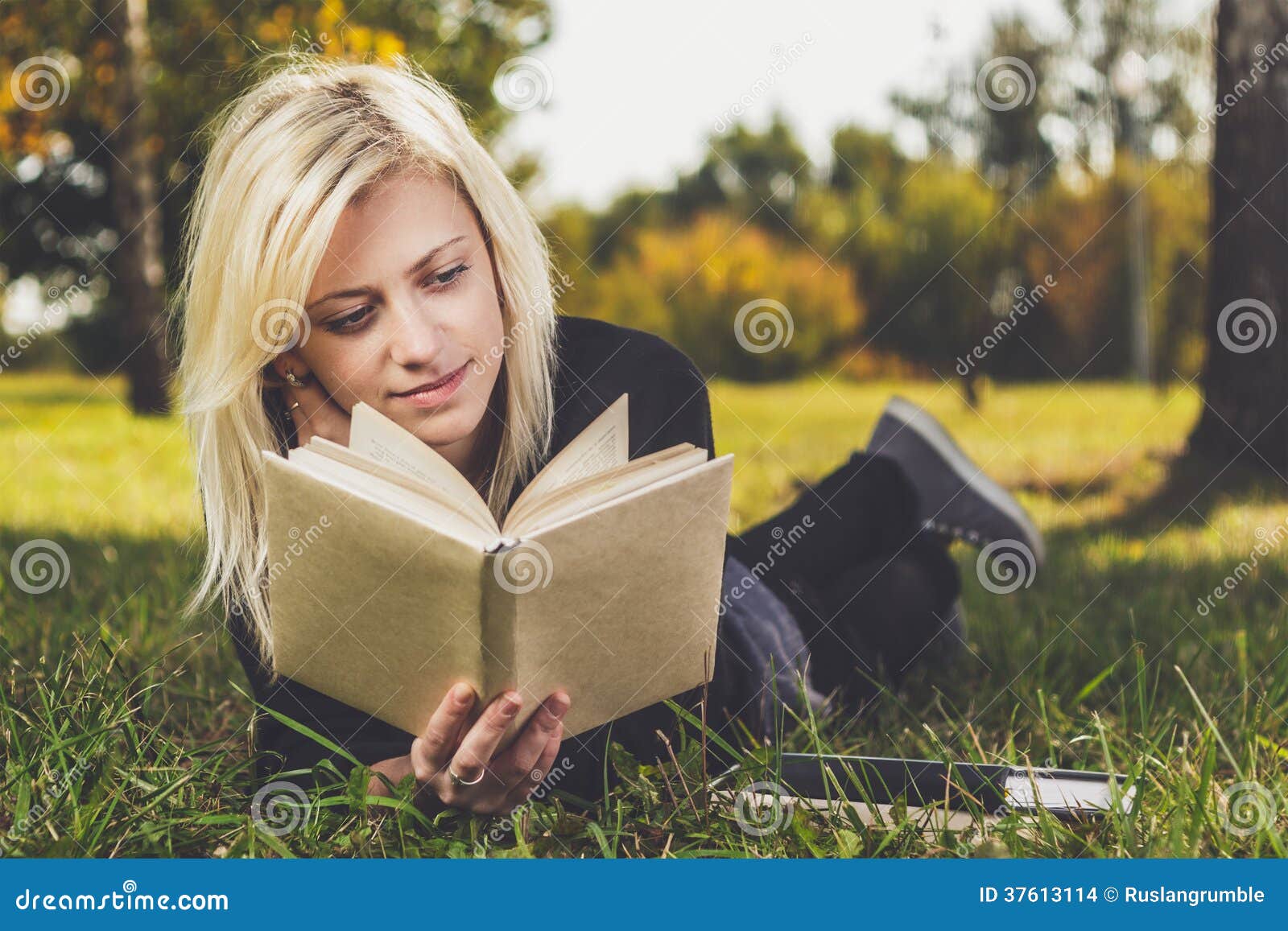 Girl Reading in Park on Grass Stock Photo - Image of modern, person ...