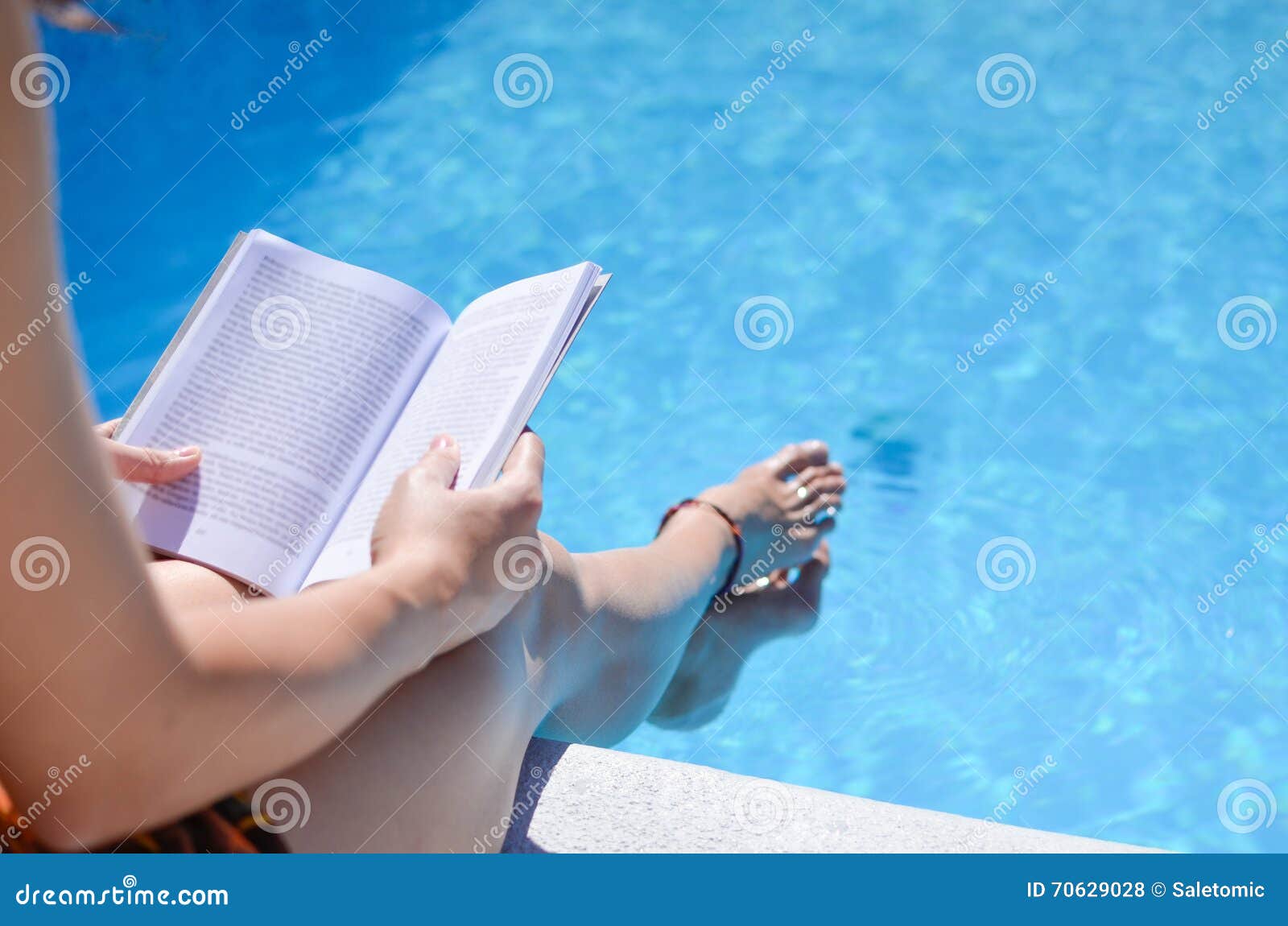 Girl reading by the pool stock photo. Image of exterior - 70629028