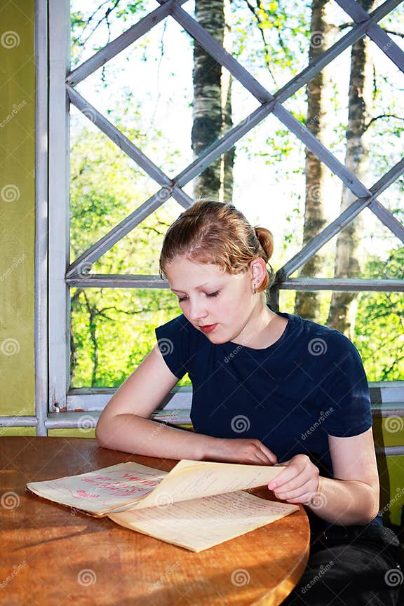 Girl reading by the window stock image. Image of green - 10875873