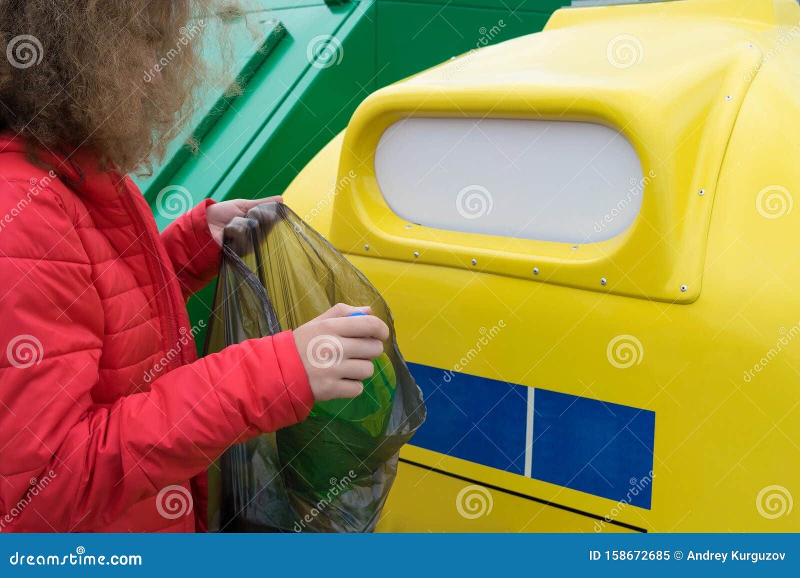 A Girl in a Red Jacket Pulls Out a Plastic Bottle from a Garbage Bag To ...