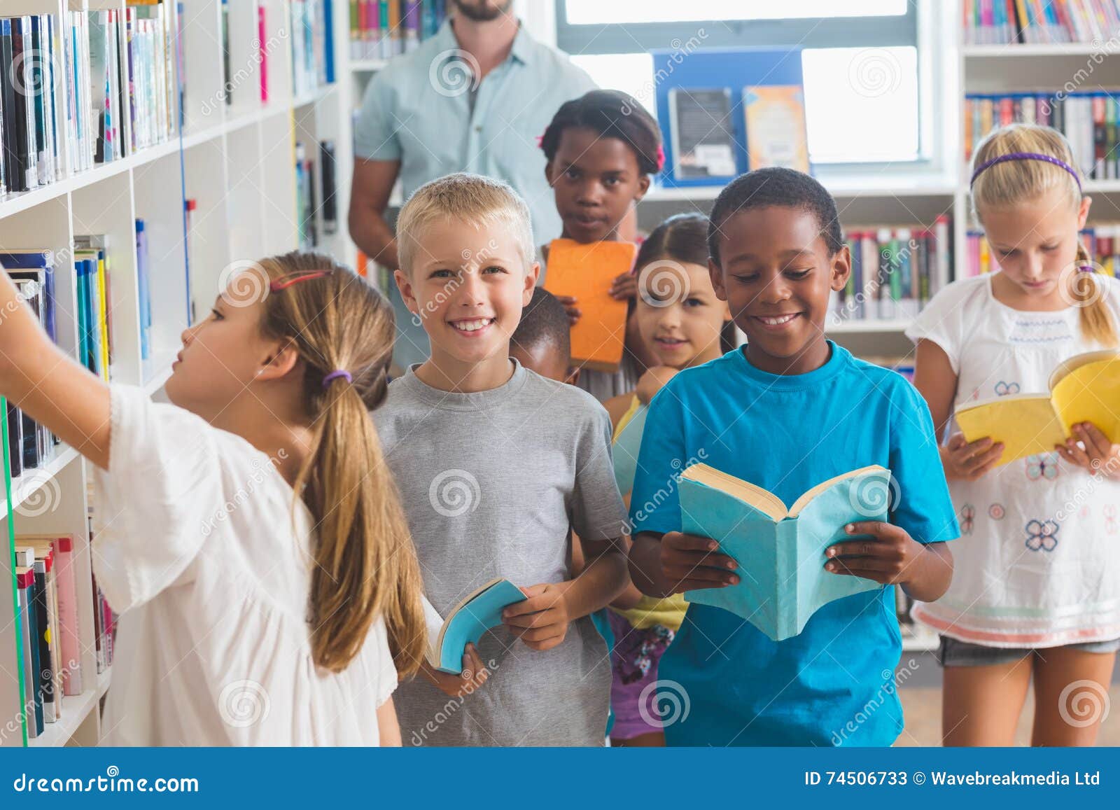 Girl Removing Book from Bookshelf in Library Stock Image - Image of ...