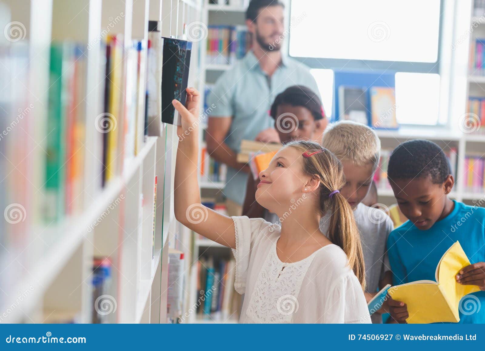 Girl Removing Book from Bookshelf in Library Stock Image - Image of ...