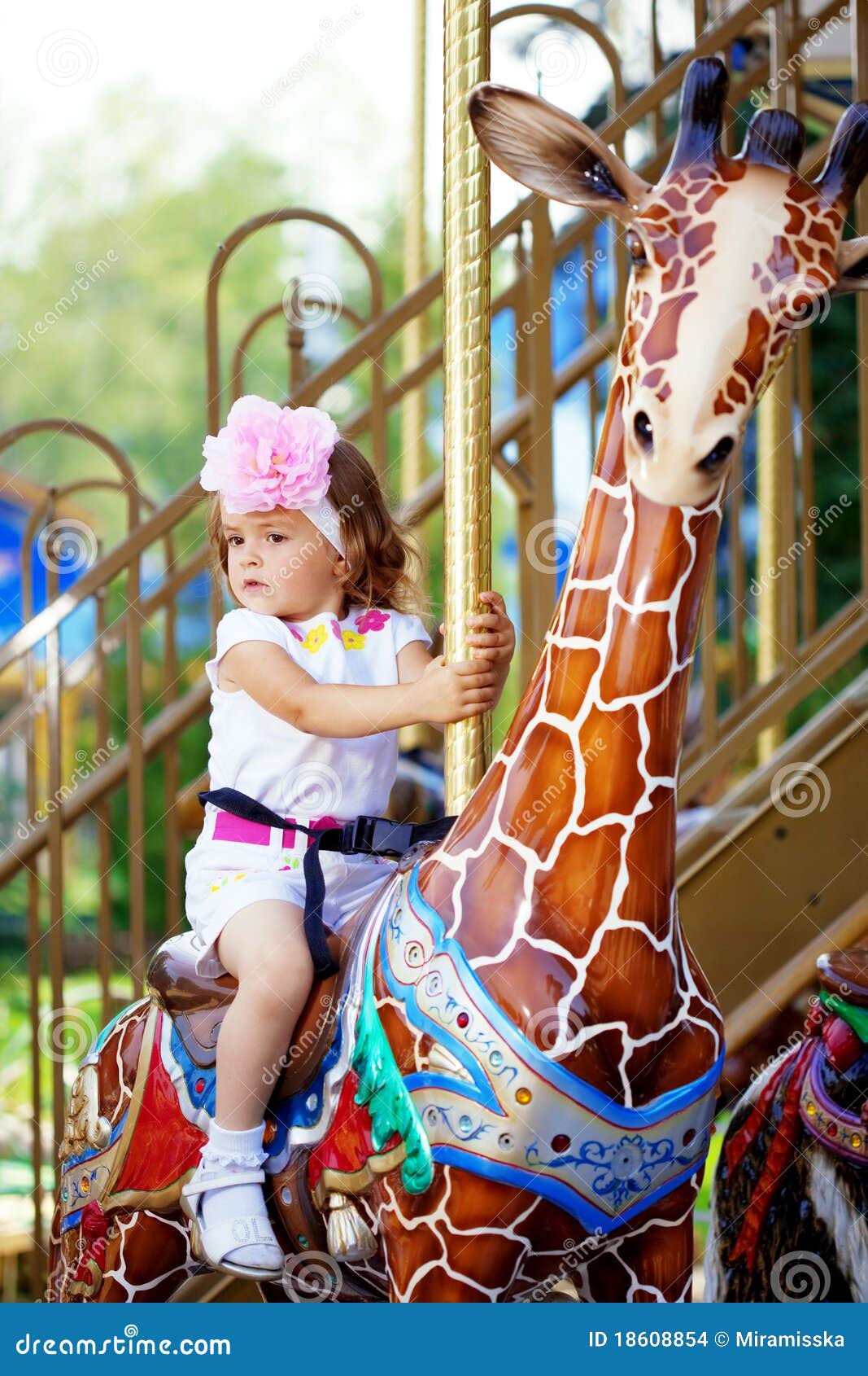 Girl riding on a carousel stock photo. Image of lights - 18608854