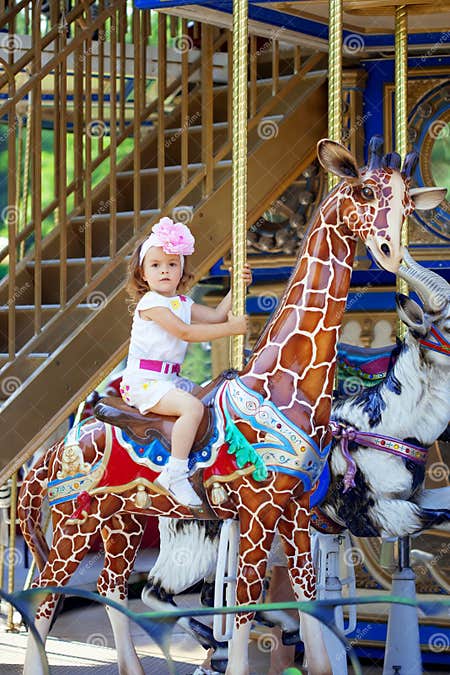 Girl riding on a carousel stock image. Image of circle - 18608997