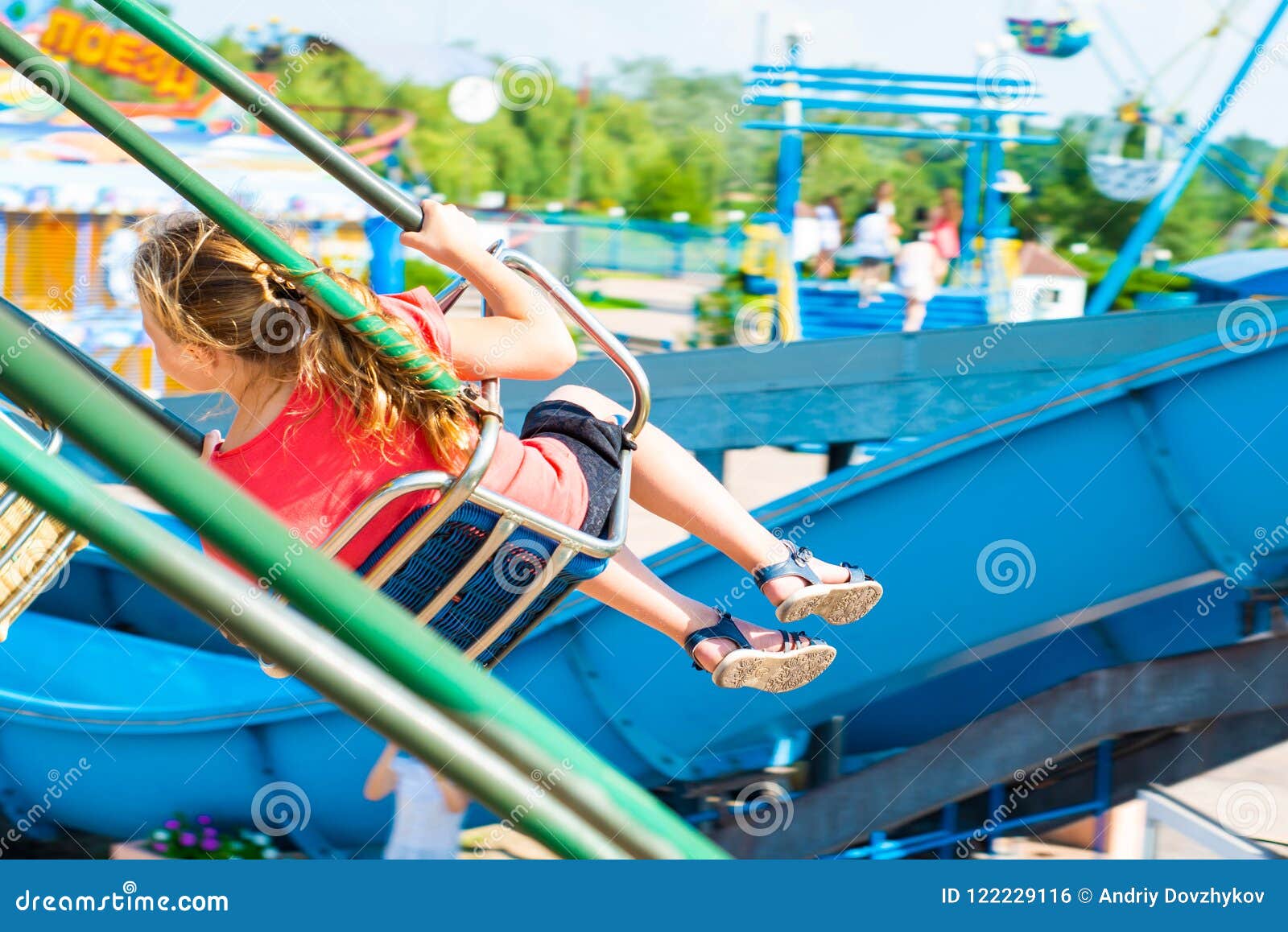 The Girl is Riding a Carousel at High Speed on a Swing. Stock Photo ...