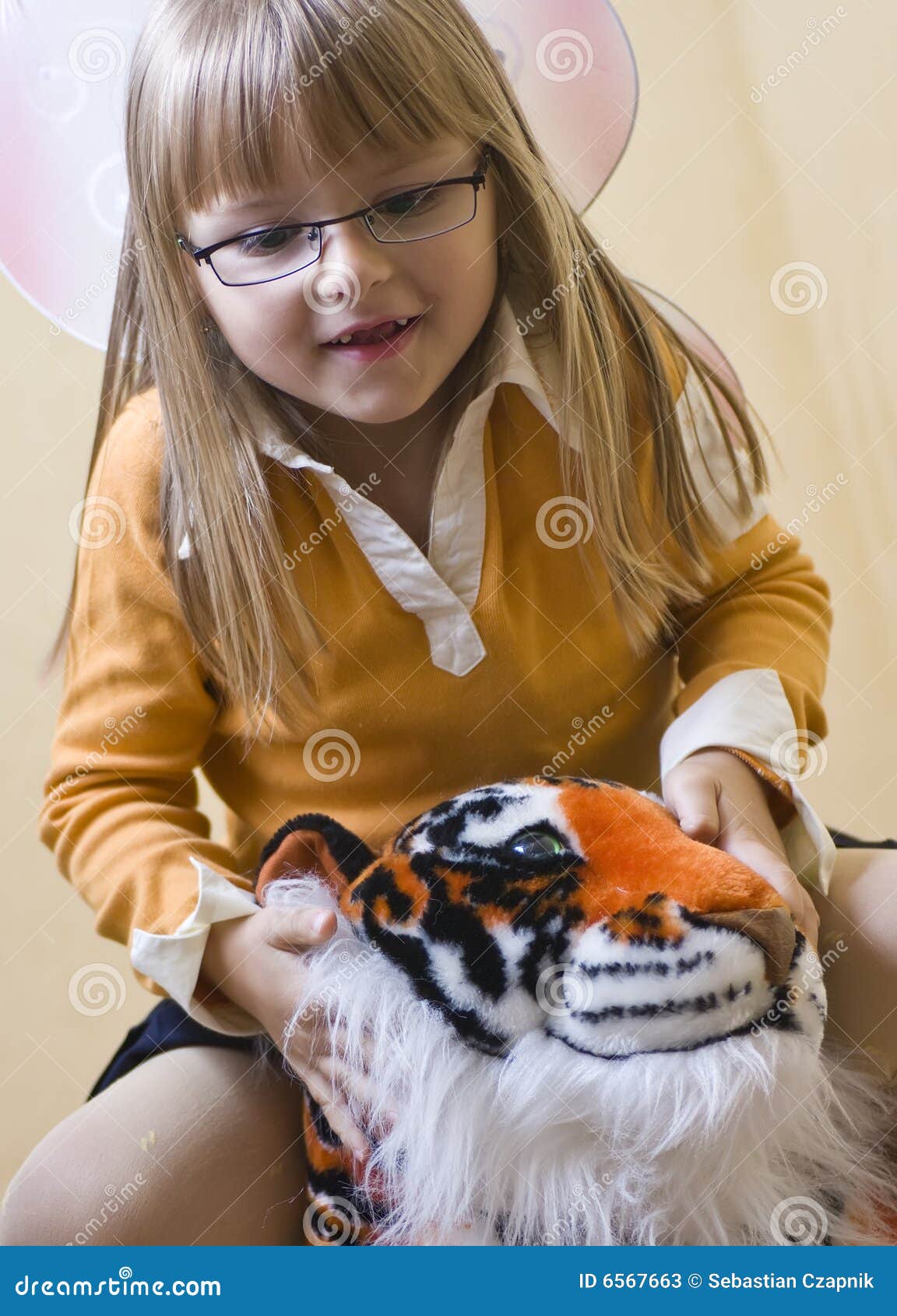 Girl riding toy tiger stock image. Image of girl, ears - 6567663