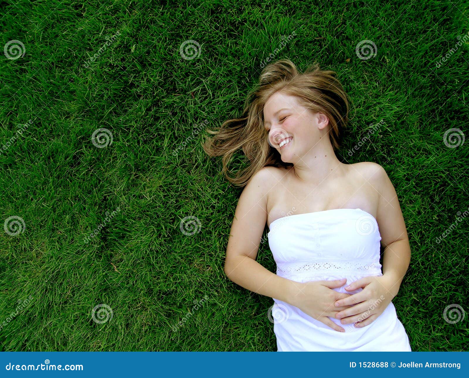 Girl Rolling in Grass stock photo. Image of grass, laying - 1528688