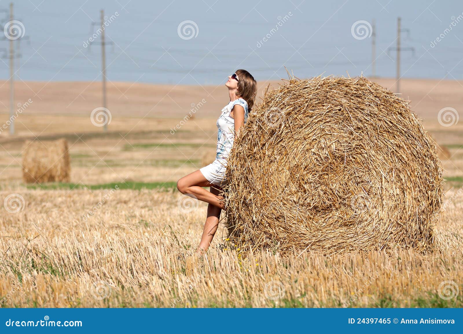 Girl and round haystack stock image. Image of legs, agriculture - 24397465