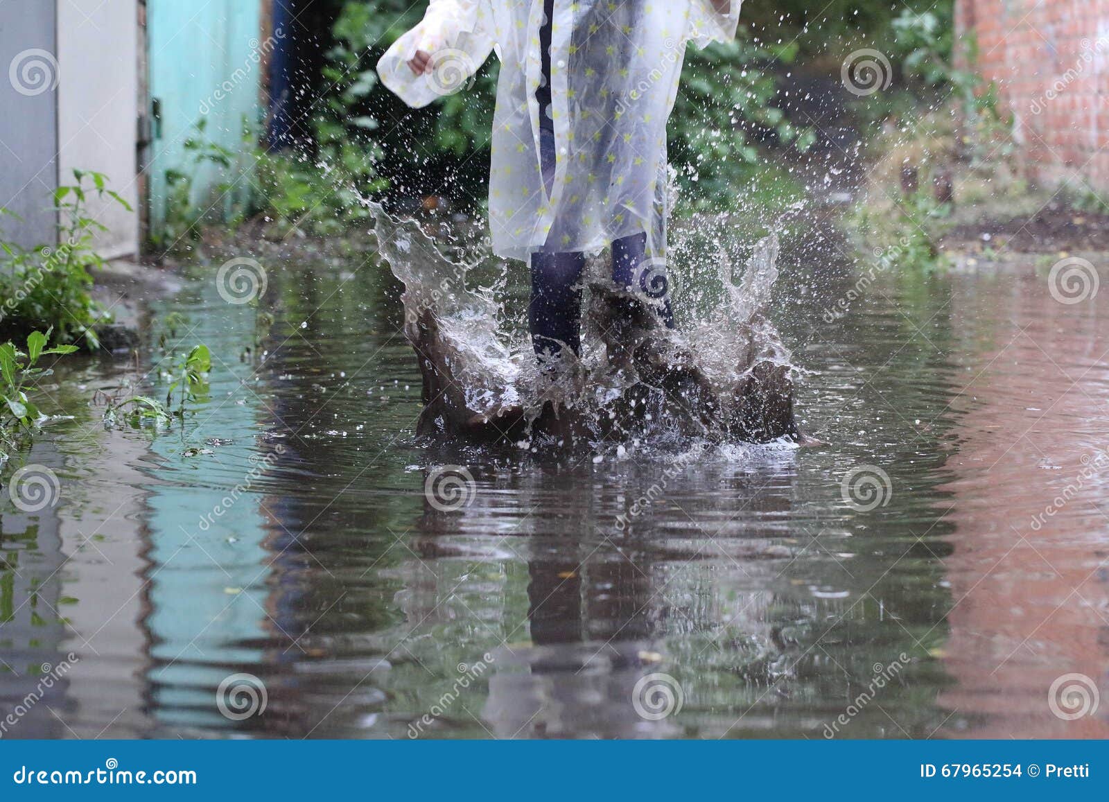Girl in Rubber Boots Jumping in a Puddle Stock Photo - Image of puddle ...