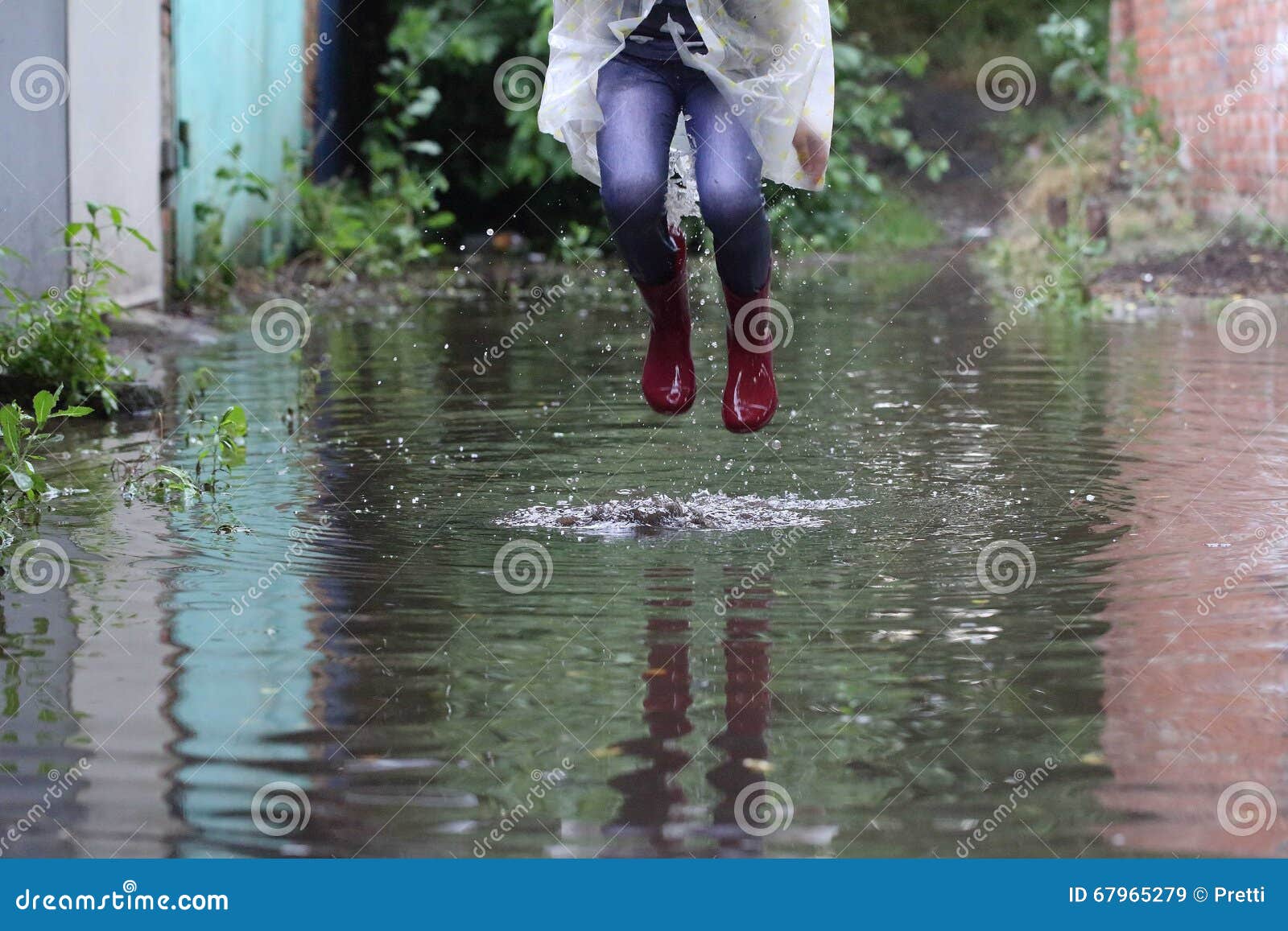 Girl in Rubber Boots Jumping in a Puddle Stock Image - Image of grass ...