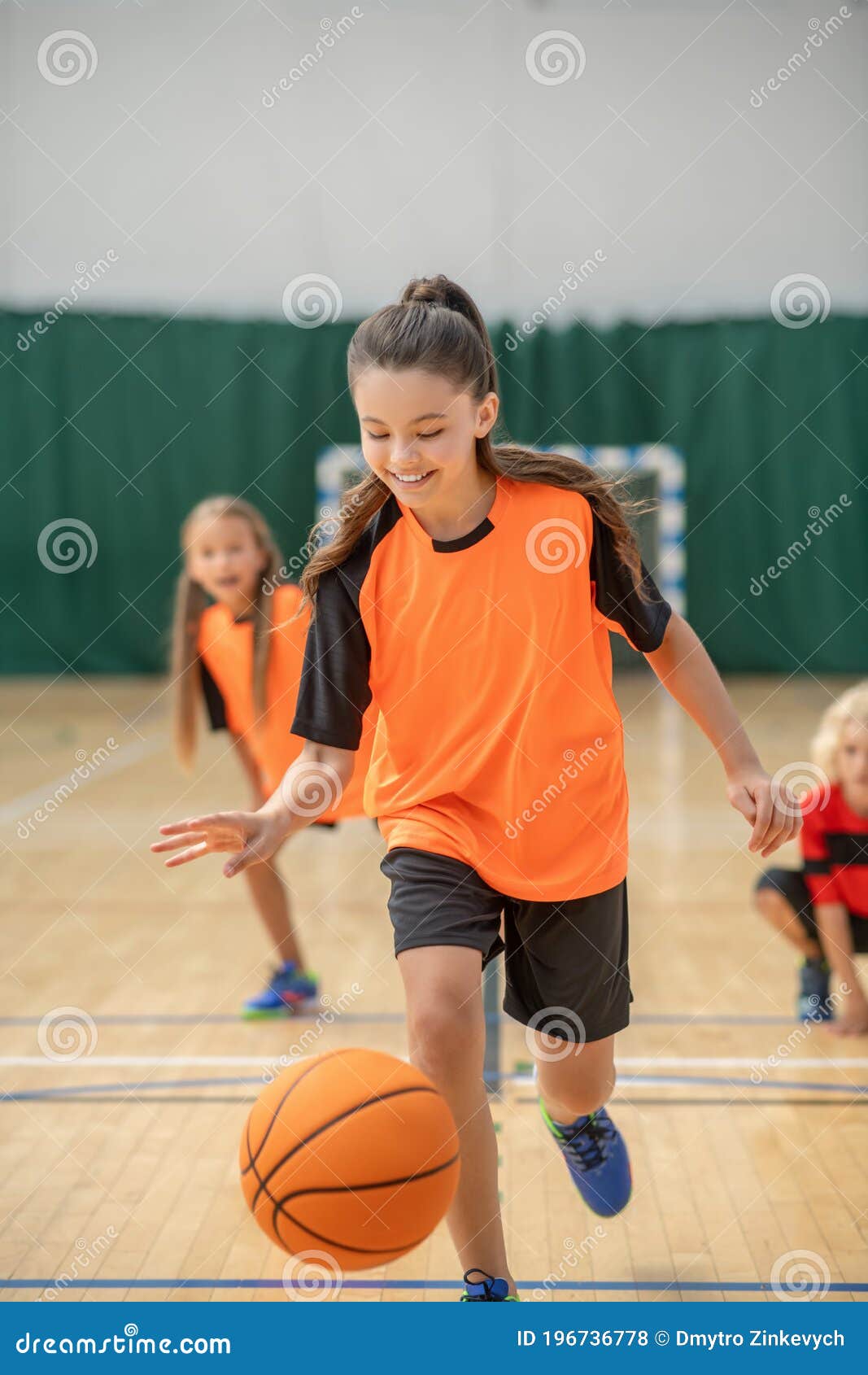 A Girl Running with a Ball and Looking Involved Stock Photo - Image of ...