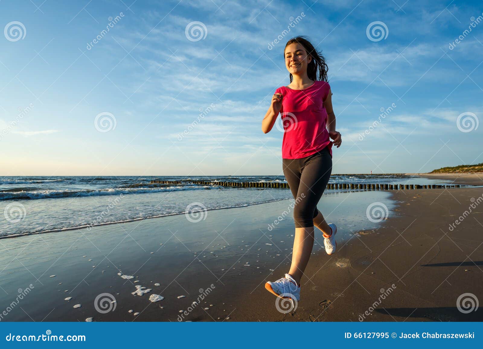 Girl running on beach stock image. Image of leap, leaping - 66127995