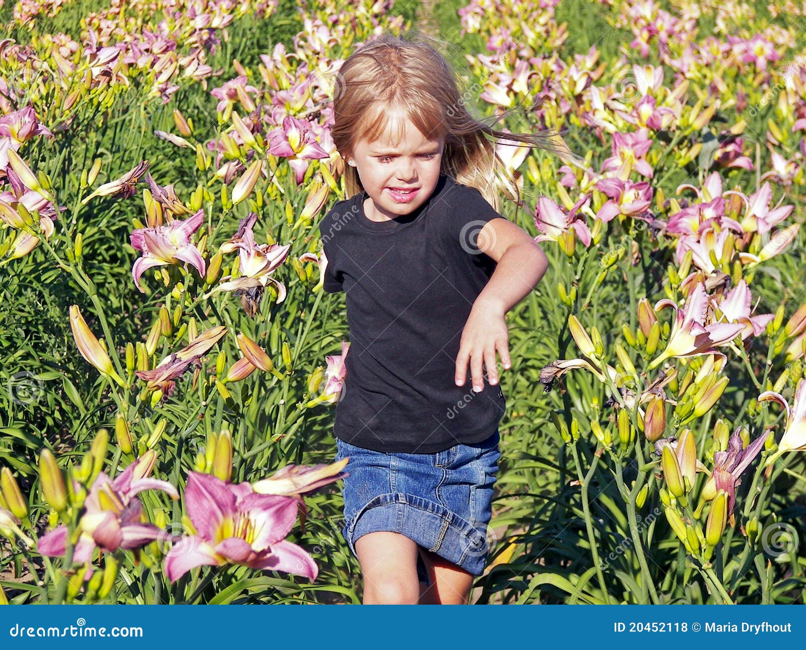 Girl running in day lilies stock photo. Image of nature - 20452118