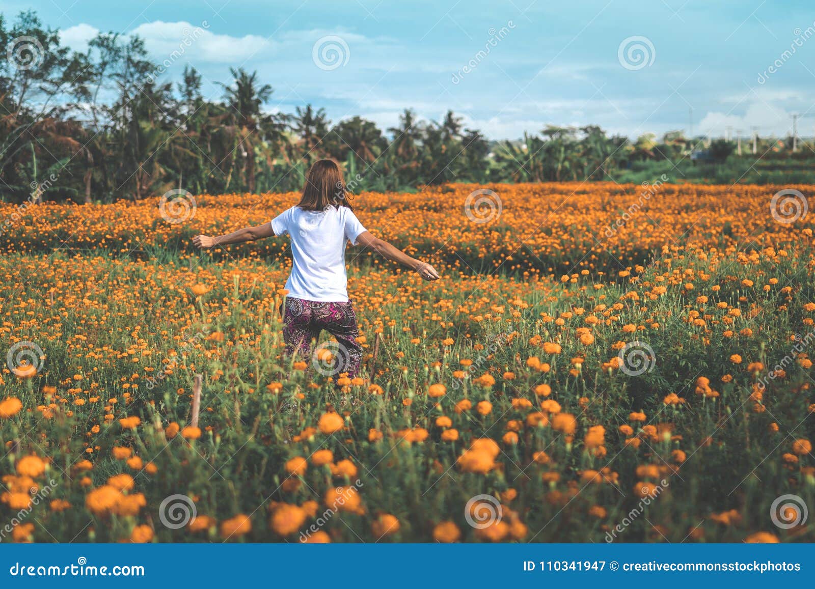 Girl Running On Yellow Flowers Picture. Image: 110341947