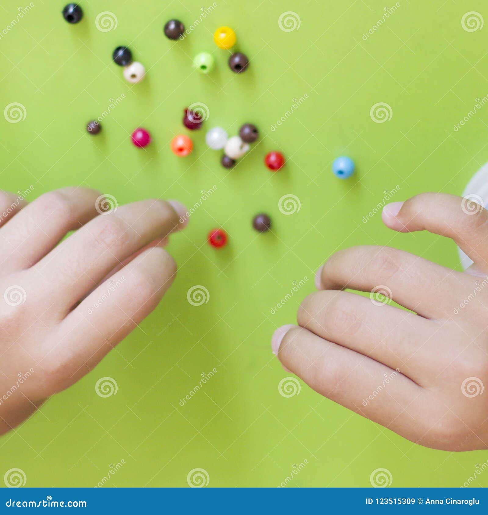 Girl`s Hand Stringing Beads on a String. Needlework and Craft Stock ...