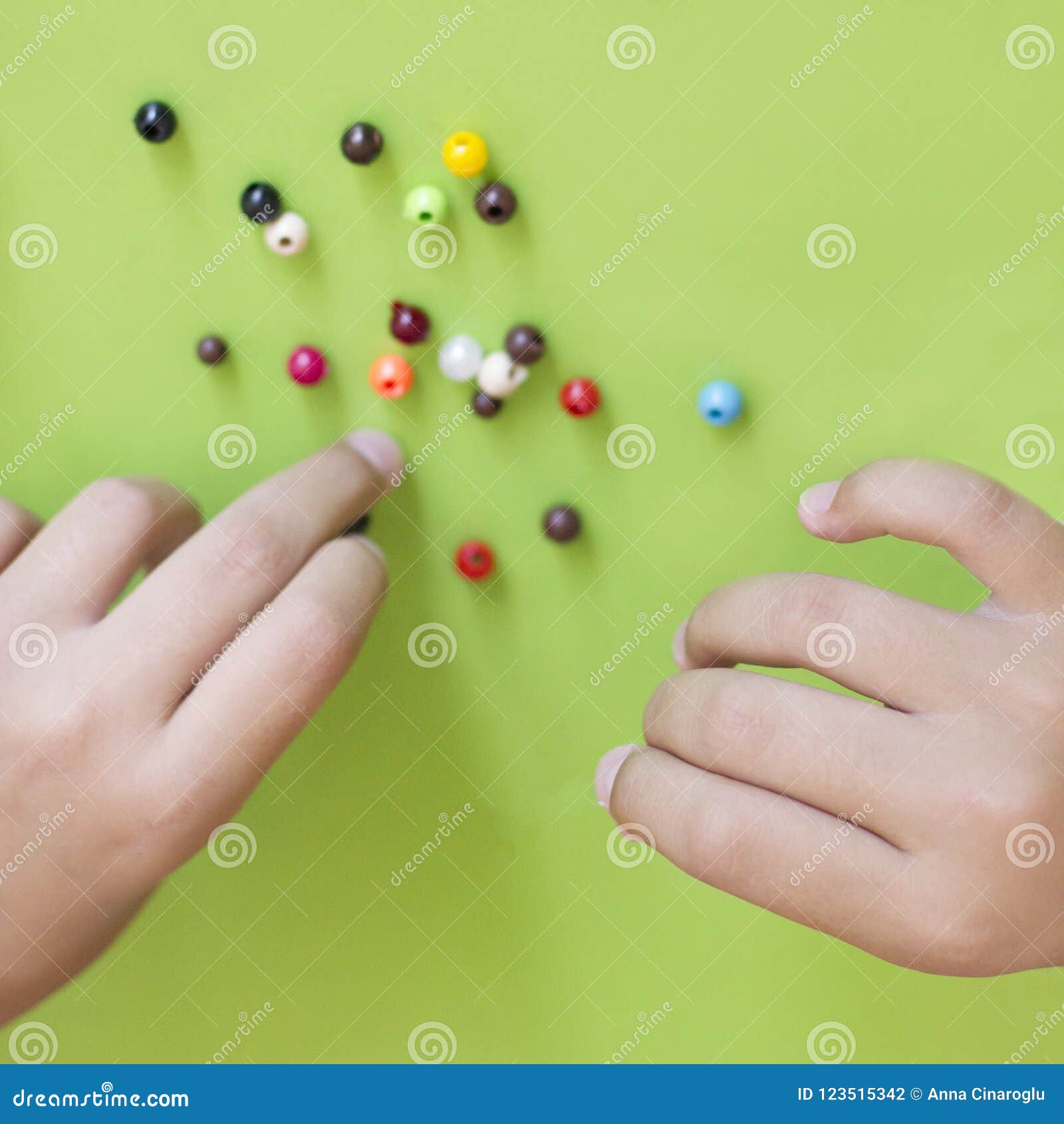 Girl`s Hand Stringing Beads on a String. Needlework and Craft Stock ...
