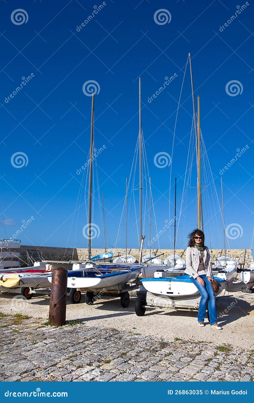 Girl and sailboats stock image. Image of posing, sitting - 26863035