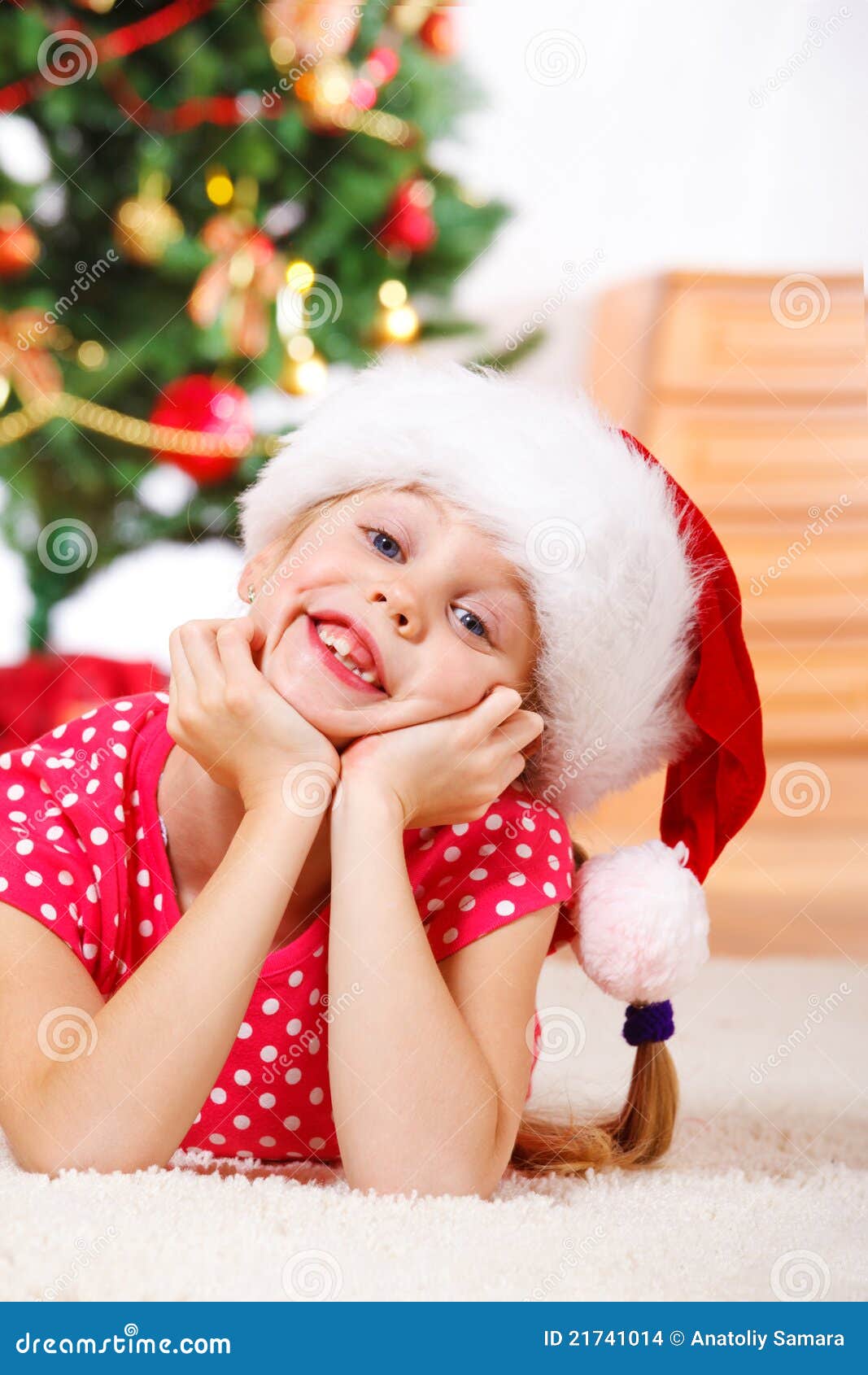 Girl in Santa hat stock photo. Image of celebration, lying - 21741014
