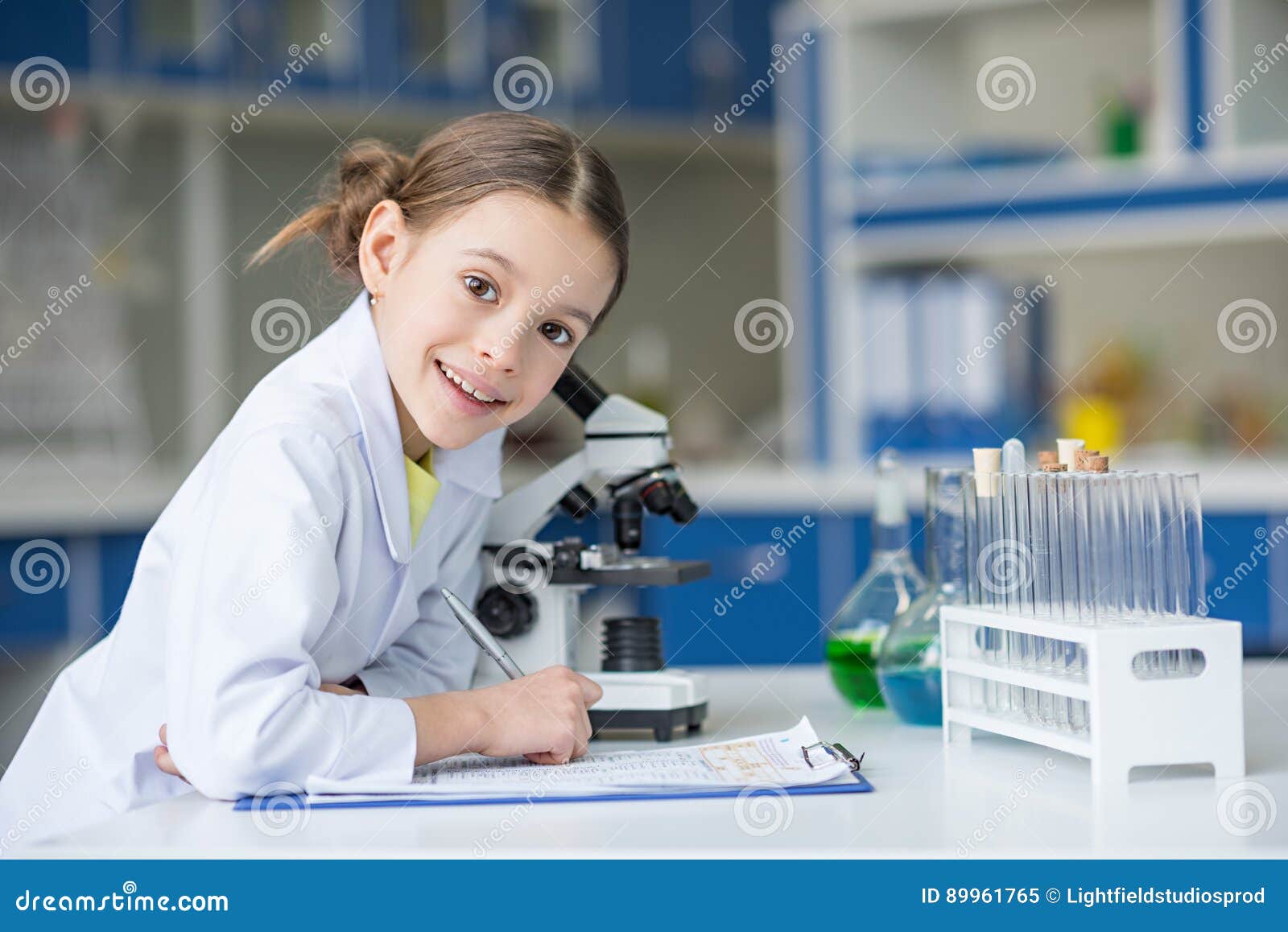 Girl Scientist in Lab Coat Writing in Clipboard Stock Image - Image of ...
