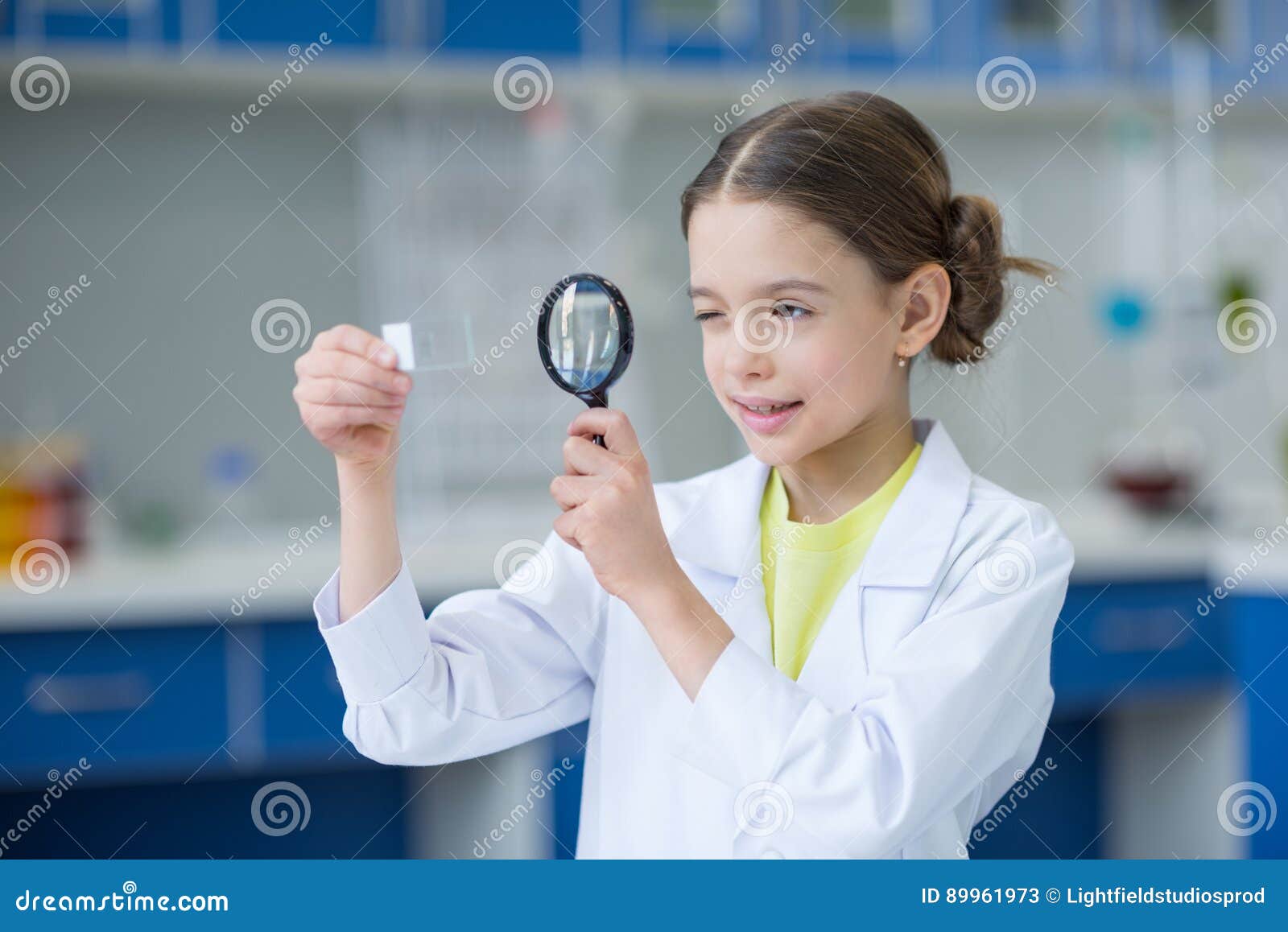 Girl Scientist Looking at Glass Microscope Slide through Magnifier ...