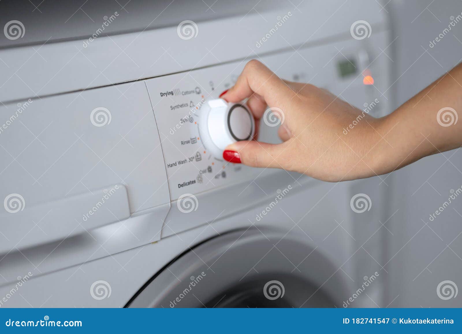 The Girl Sets the Washing Program for the Washing Machine Stock Image ...