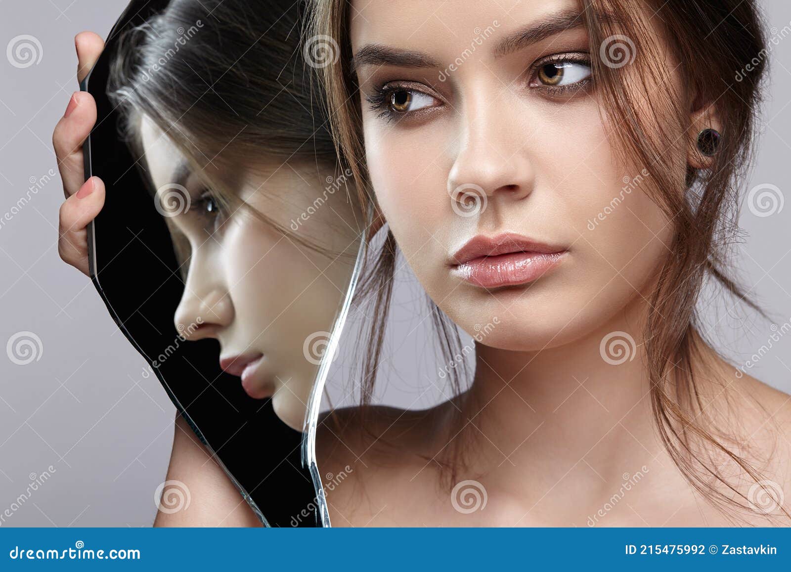 Female With Mirror Shard In Hand Posing On Gray Background. Face ...