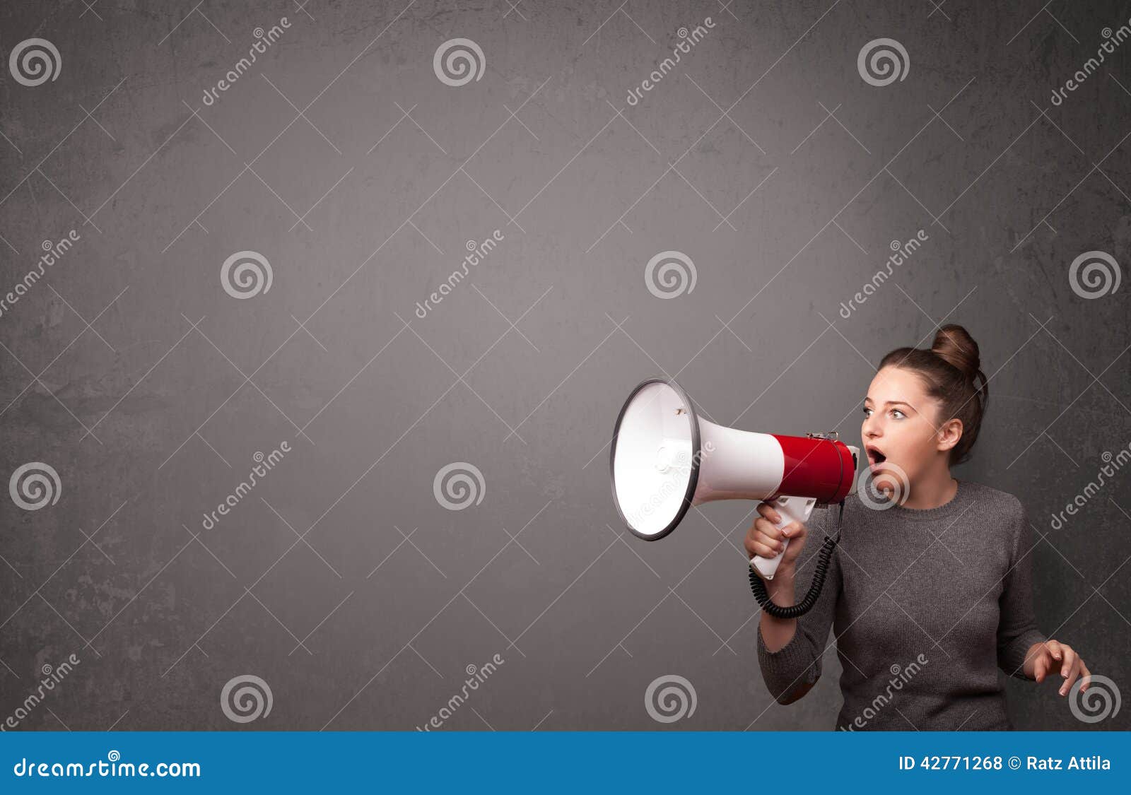 Girl Shouting into Megaphone on Copy Space Background Stock Photo ...