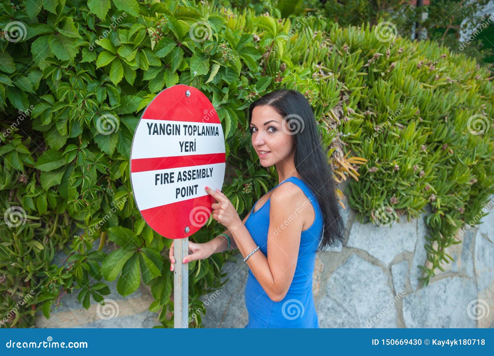 The Girl Shows on the Road Sign, Indicates the Direction of the Path ...