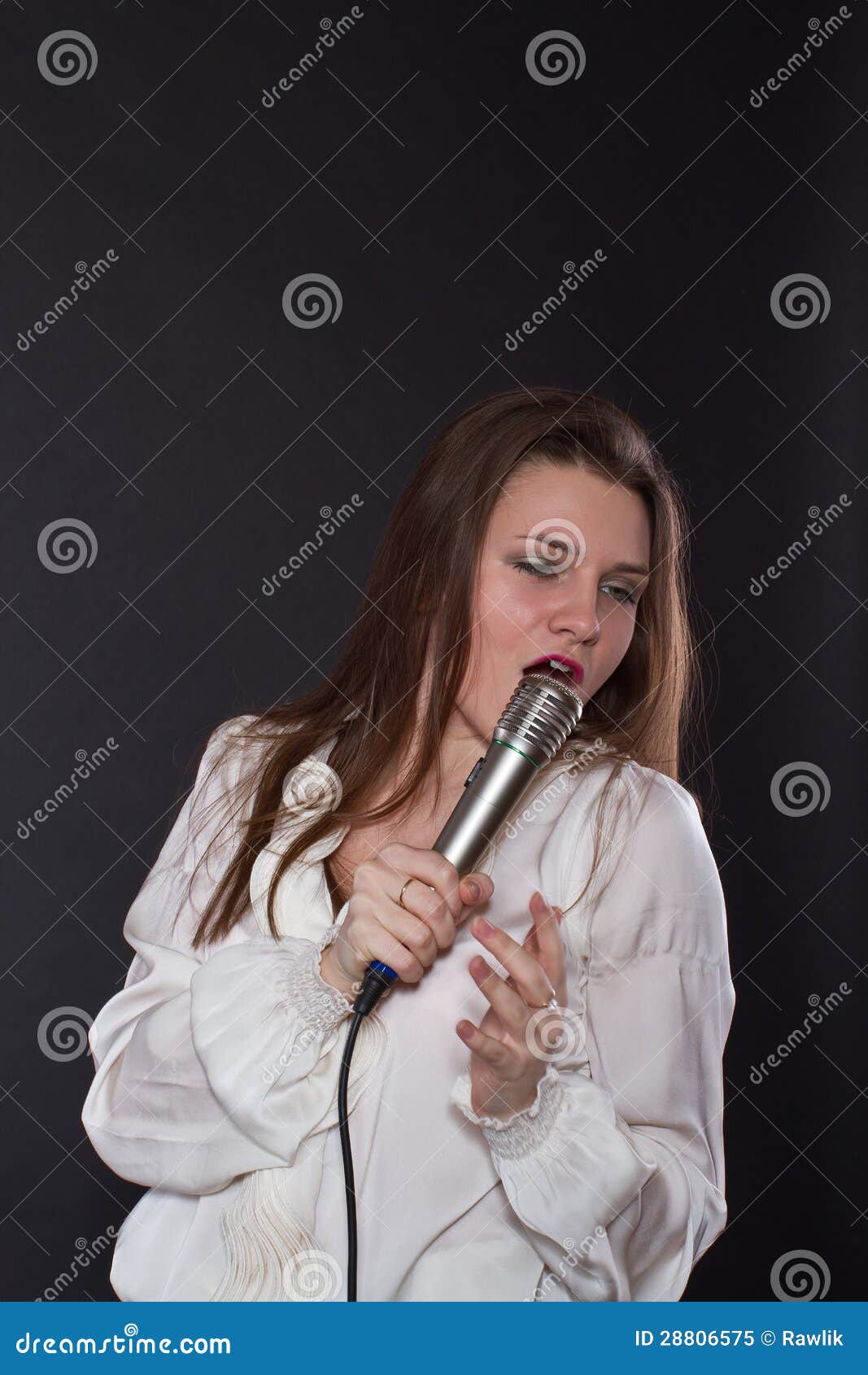 Girl Singing Into A Microphone Royalty Free Stock Photo - Image: 28806575