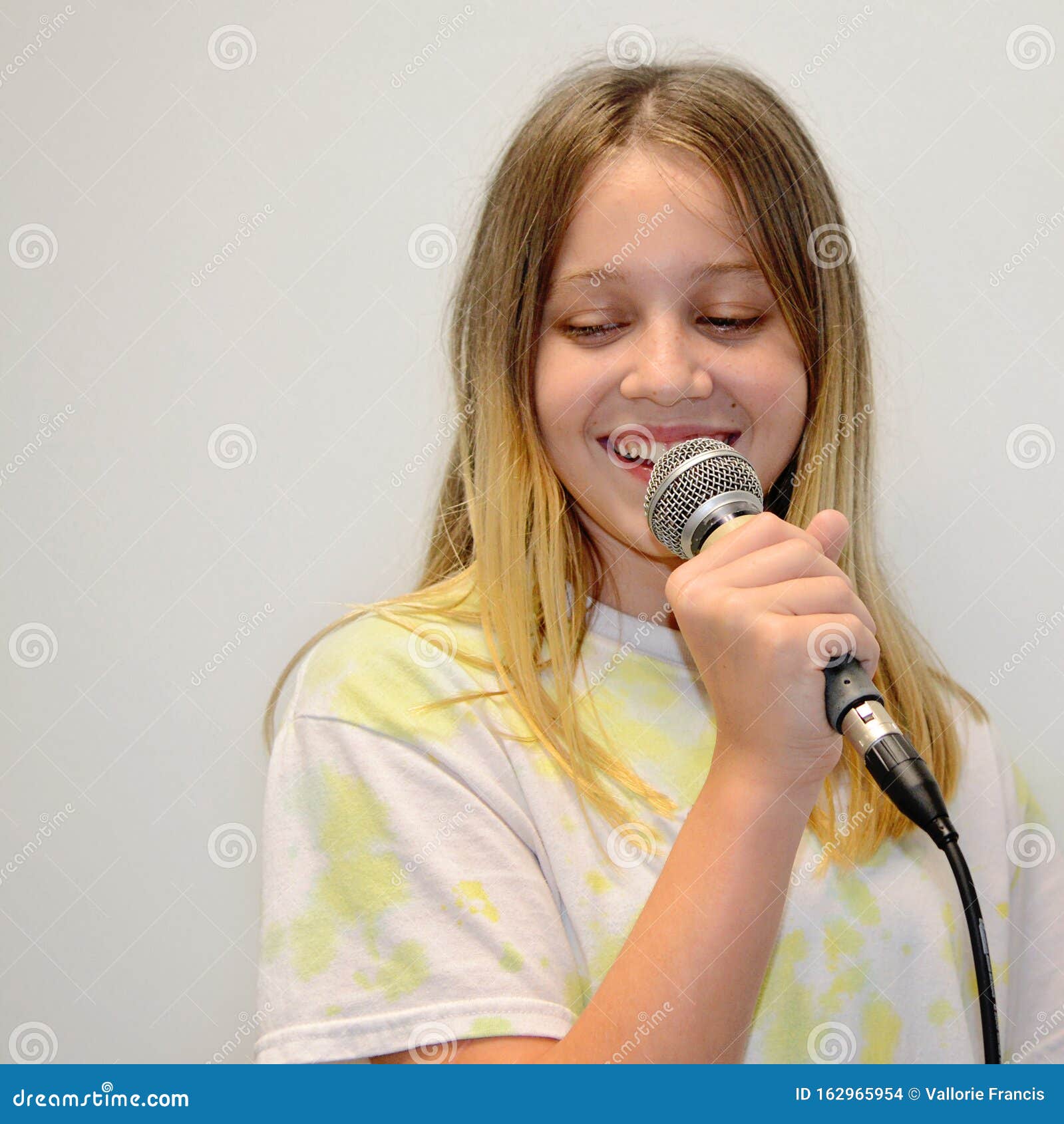 Girl Singing into Microphone Stock Photo - Image of teen, girl: 162965954