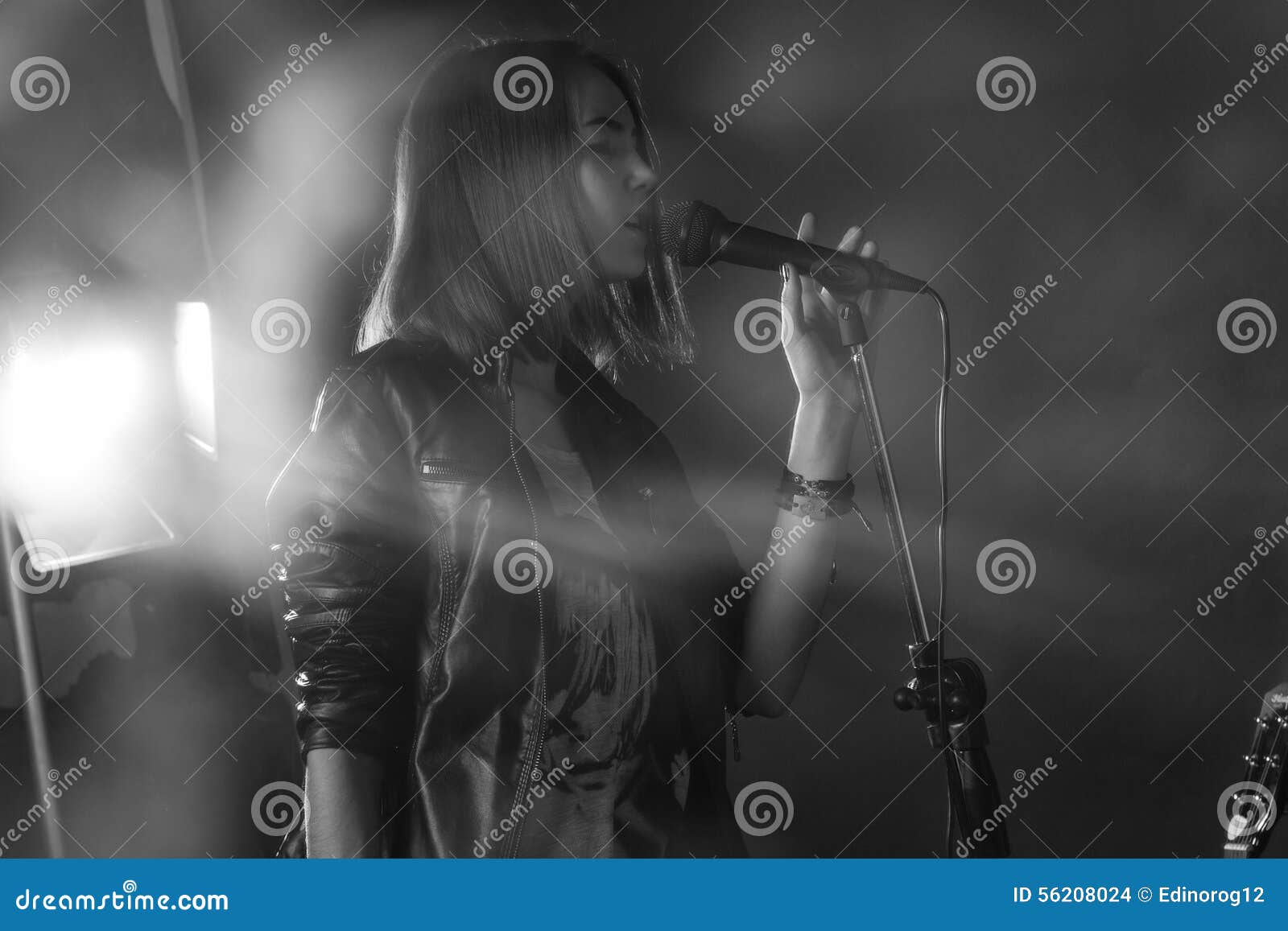 Girl Singing into a Microphone in a Studio Stock Photo - Image of ...