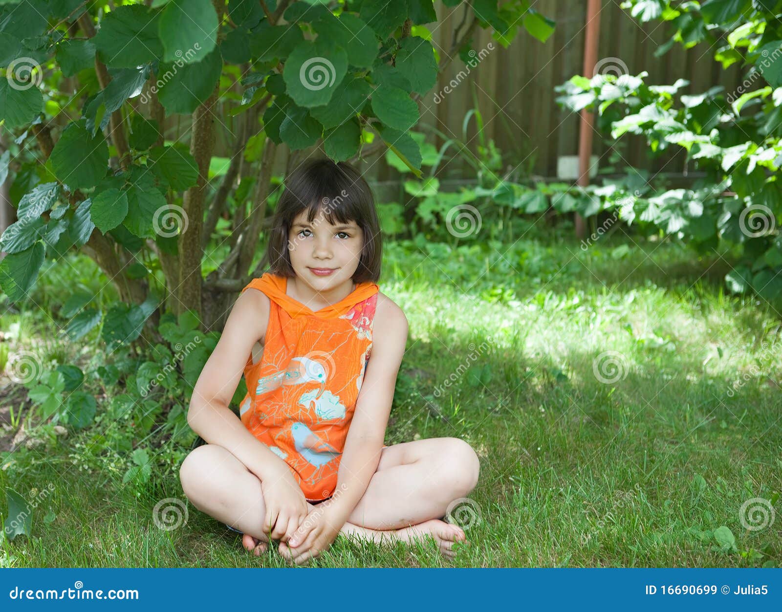 The Girl Sits on a Grass Under a Bush Stock Image - Image of human ...