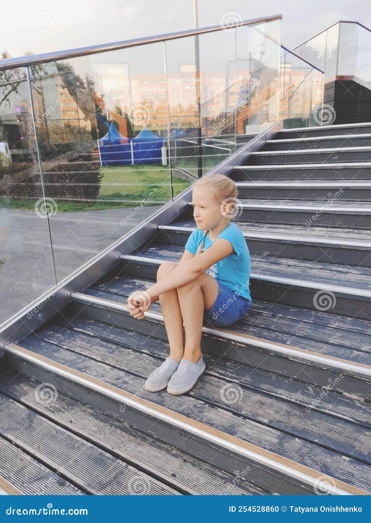 The Girl Sits Thoughtfully on the Stairs Stock Photo - Image of ...