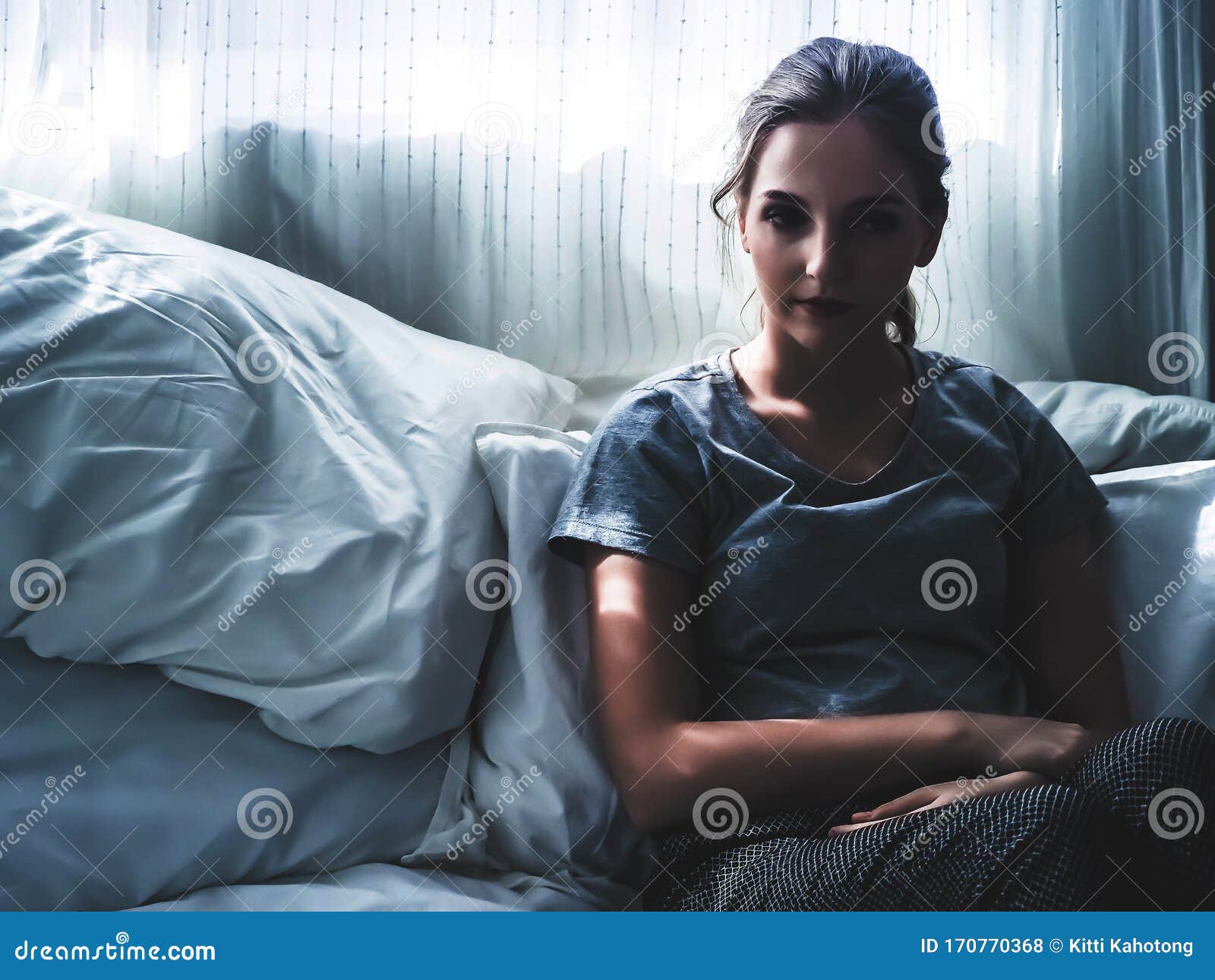 A Girl Sitting in the Bedroom she is Sad Stock Photo - Image of withe ...