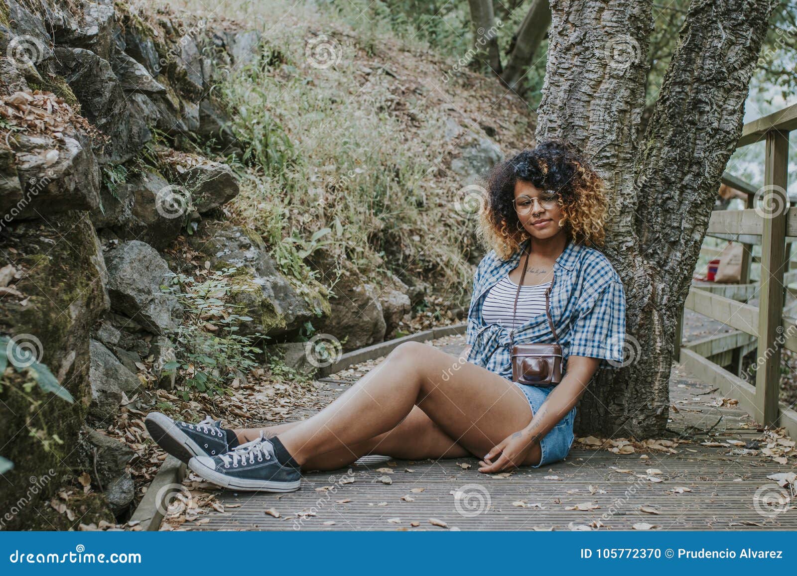 Girl sitting with camera stock photo. Image of adventure - 105772370