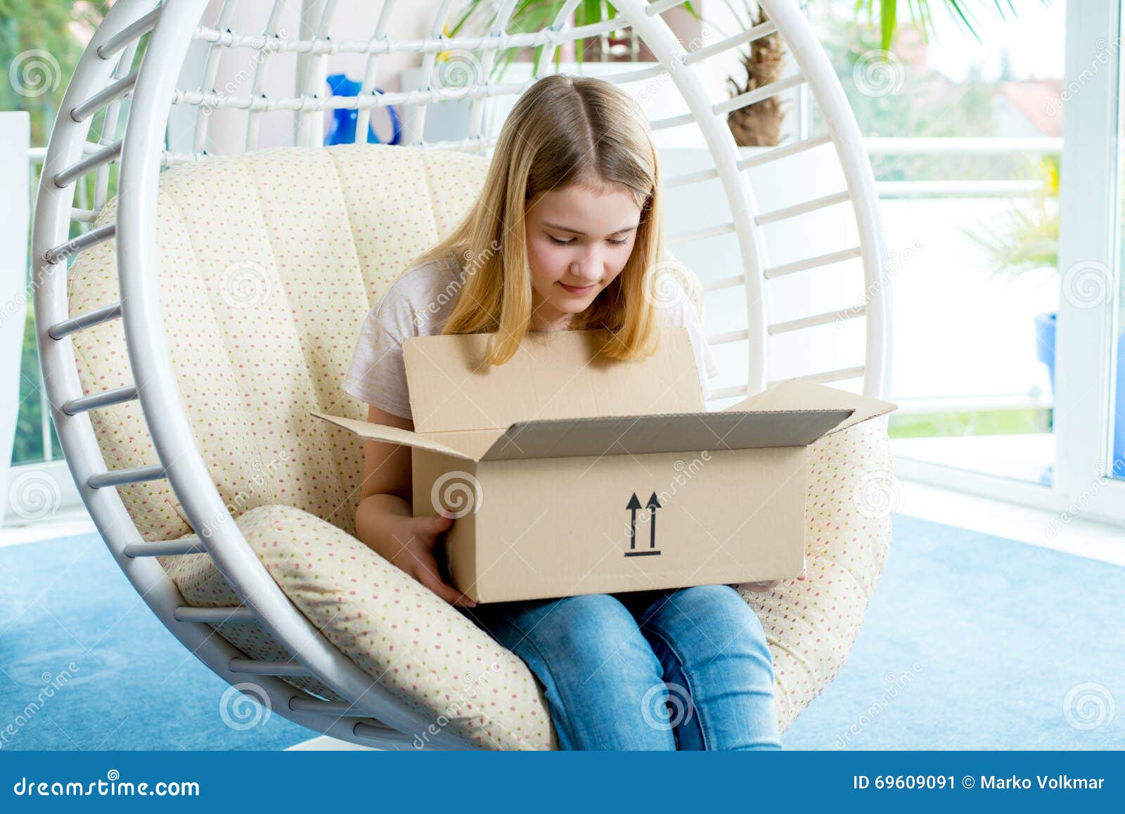 Girl Sitting in Chair and Opening a Package Stock Image - Image of ...