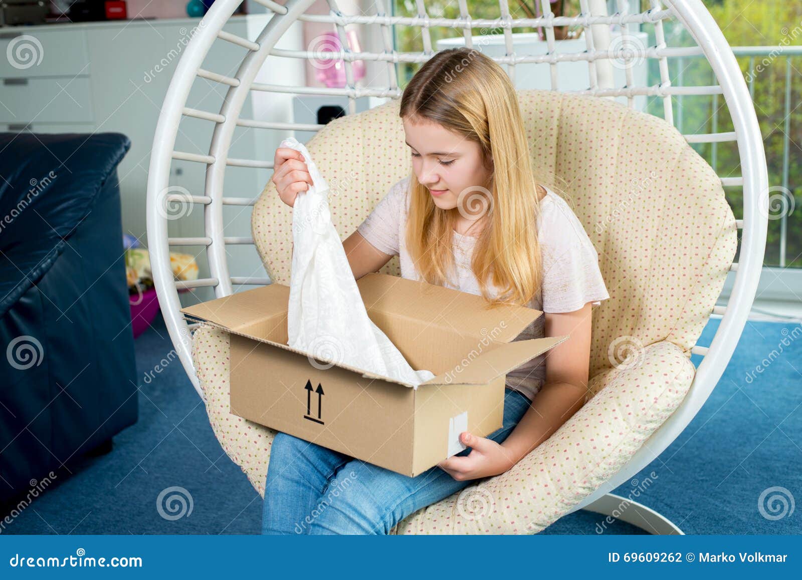 Girl Sitting in Chair and Opening a Package Stock Photo - Image of ...