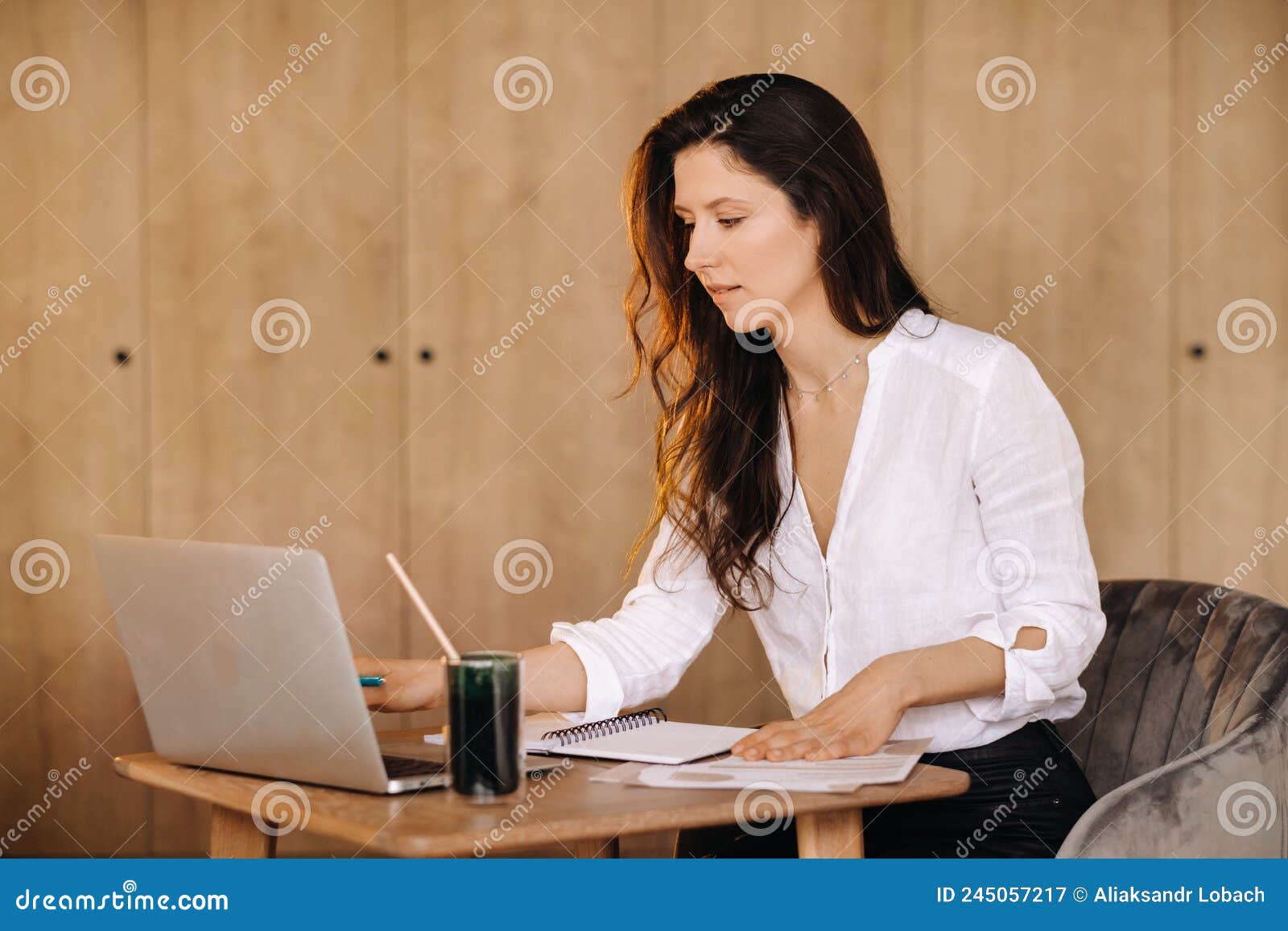 The Girl is Sitting at a Desk in the Office and Working Stock Image ...